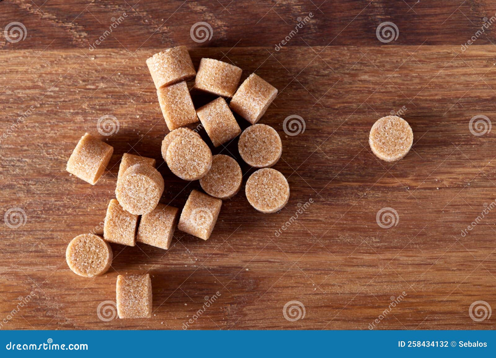 Brown Round Sugar Forms on a Old Dark Wooden Cutting Board Stock Photo ...