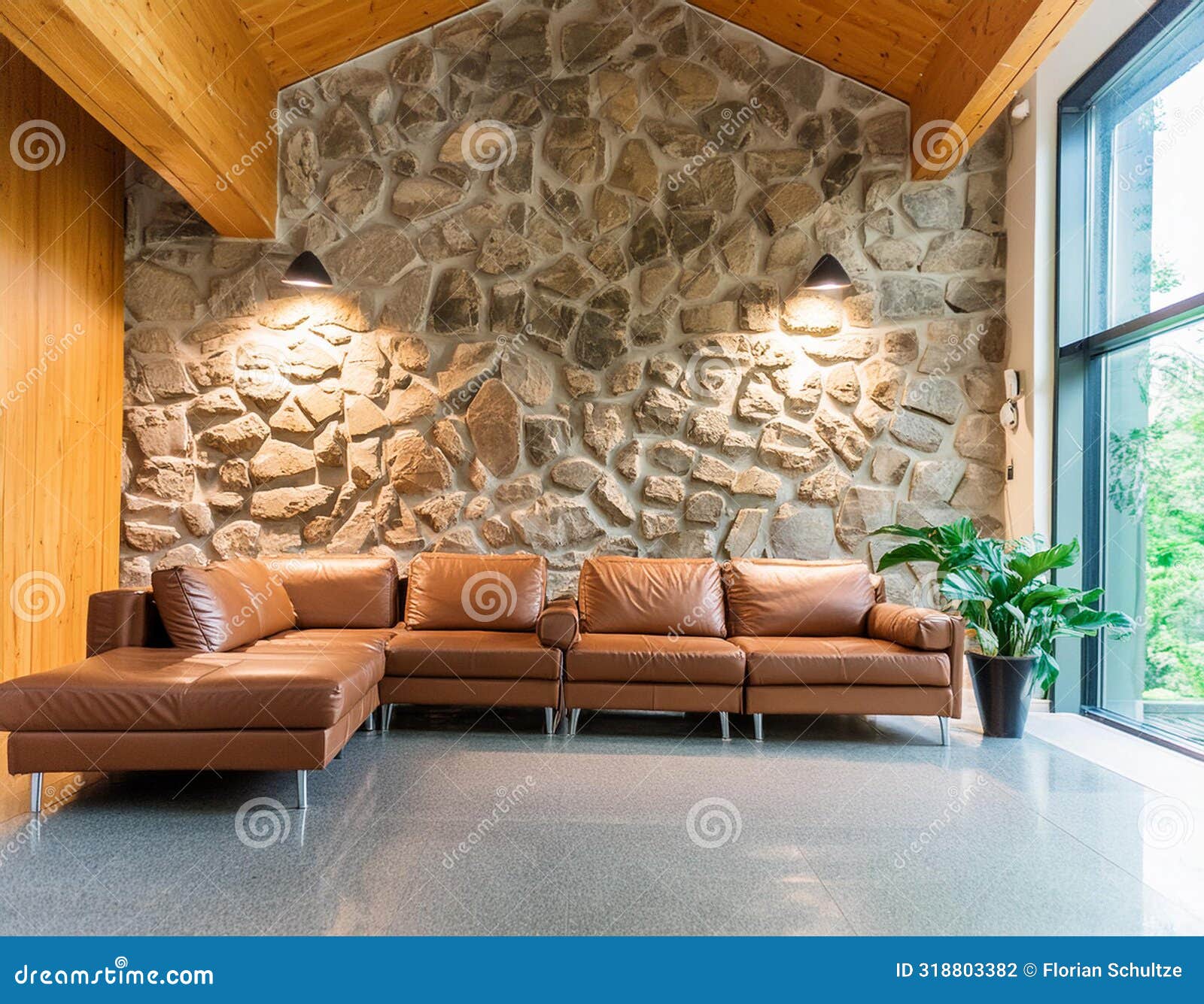 Brown Sofas Against Stone Tiles Cladding Wall In Room With High Ceiling ...