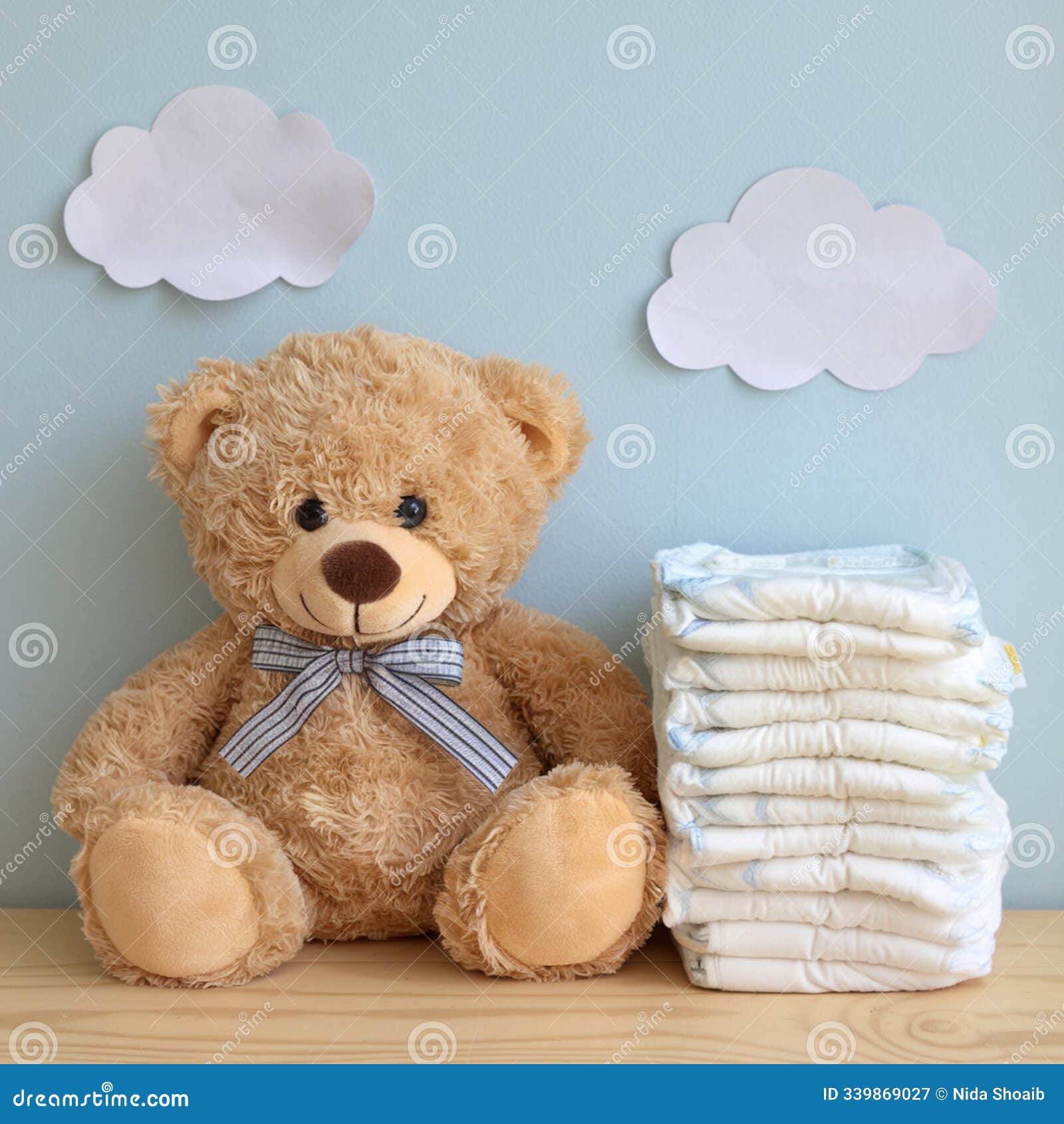 Brown Teddy Bear beside Stack of Diapers on Wooden Surface, Cloud Decor ...
