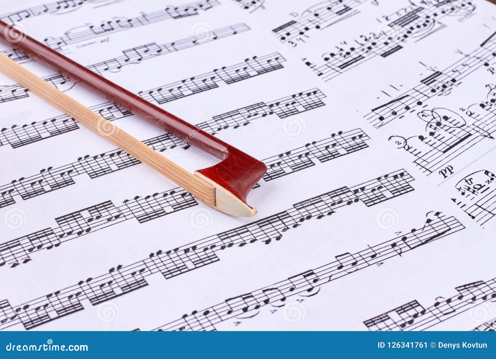 Brown Violin Bow on Musical Notes Sheets. Stock Image - Image of paper ...