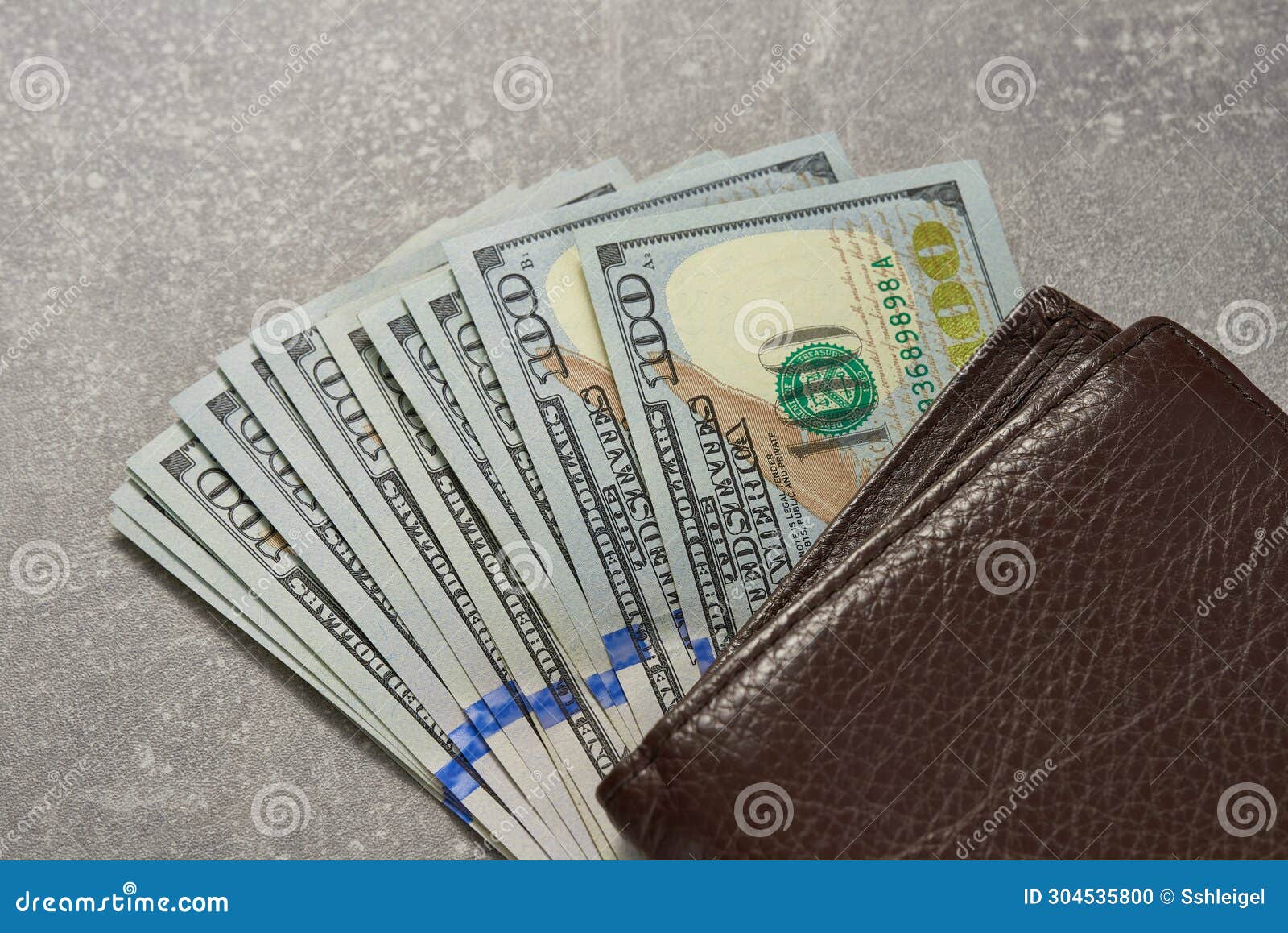 A Brown Wallet and a Stack of Many Hundred Dollar Bills. Top View Stock ...
