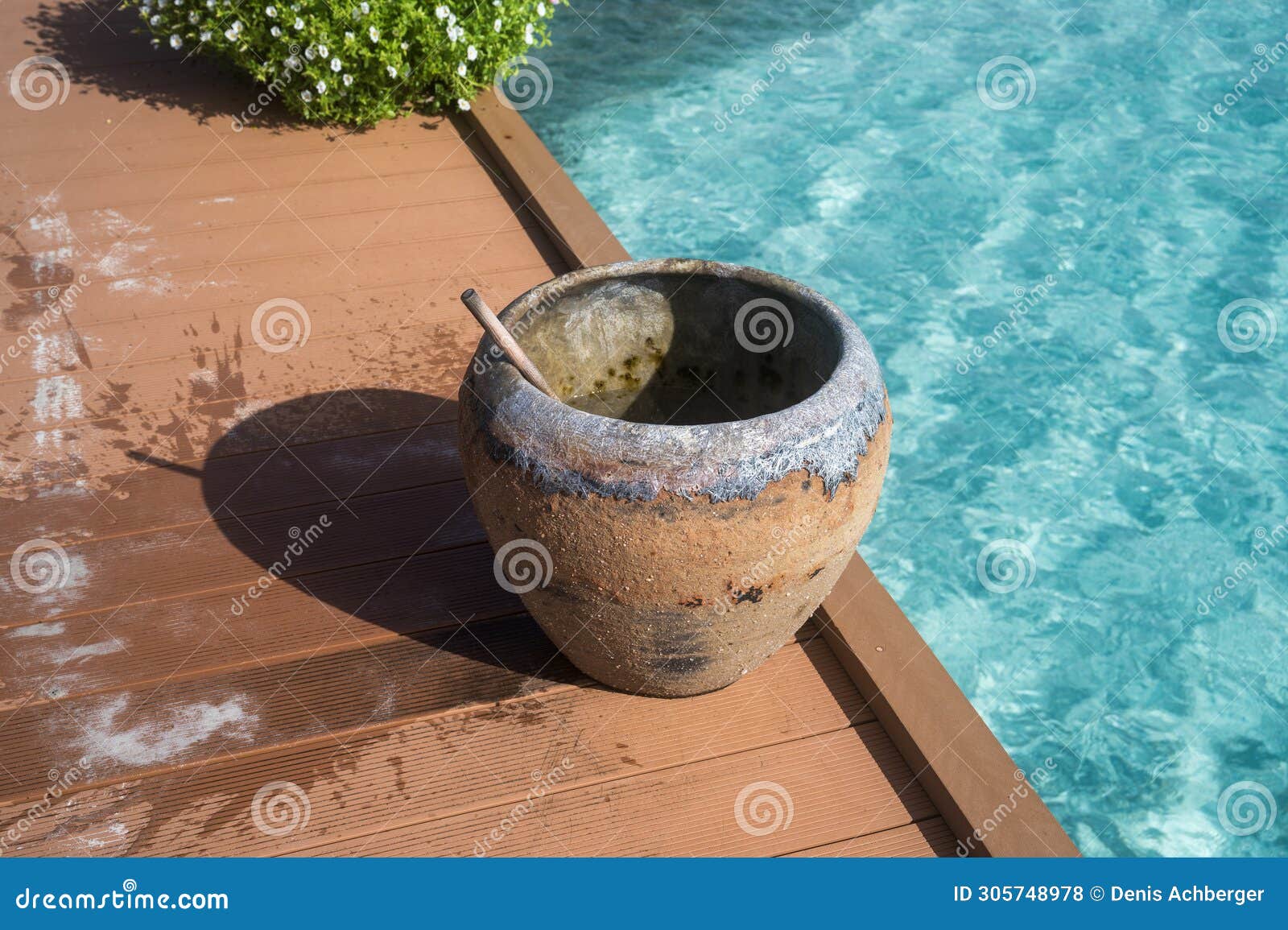 Brown Water Container. on a Wooden Bridge Under Which is Blue Water ...