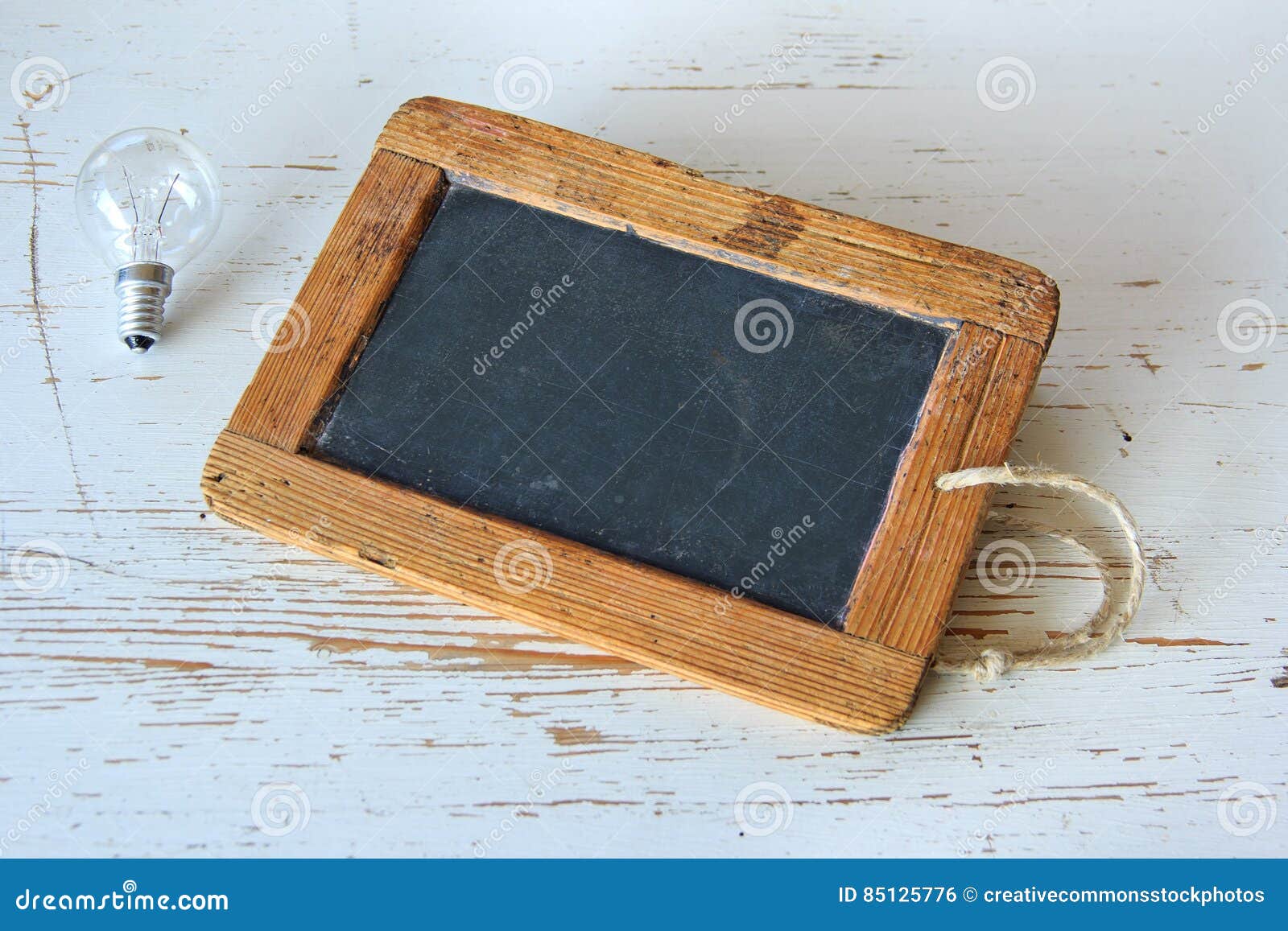 Brown Wooden Frame Beside Clear Bulb Picture. Image: 85125776