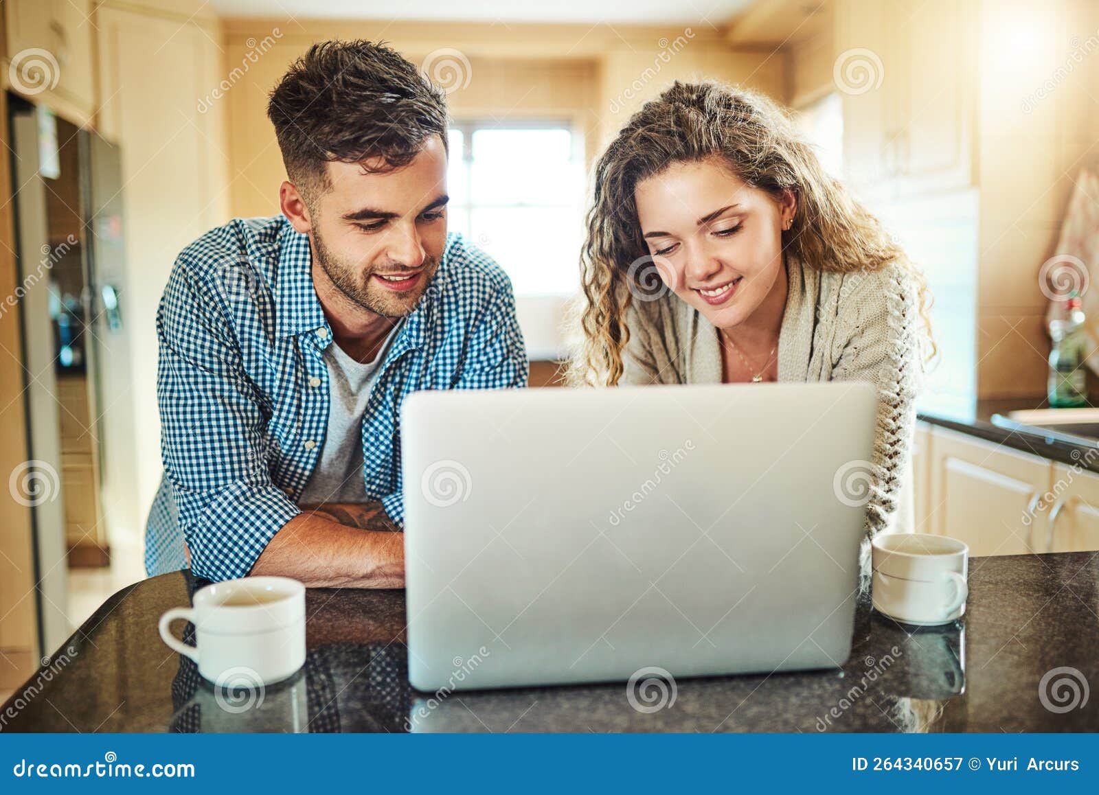 Browsing for Interesting Things To Do. a Young Couple Using a Laptop ...