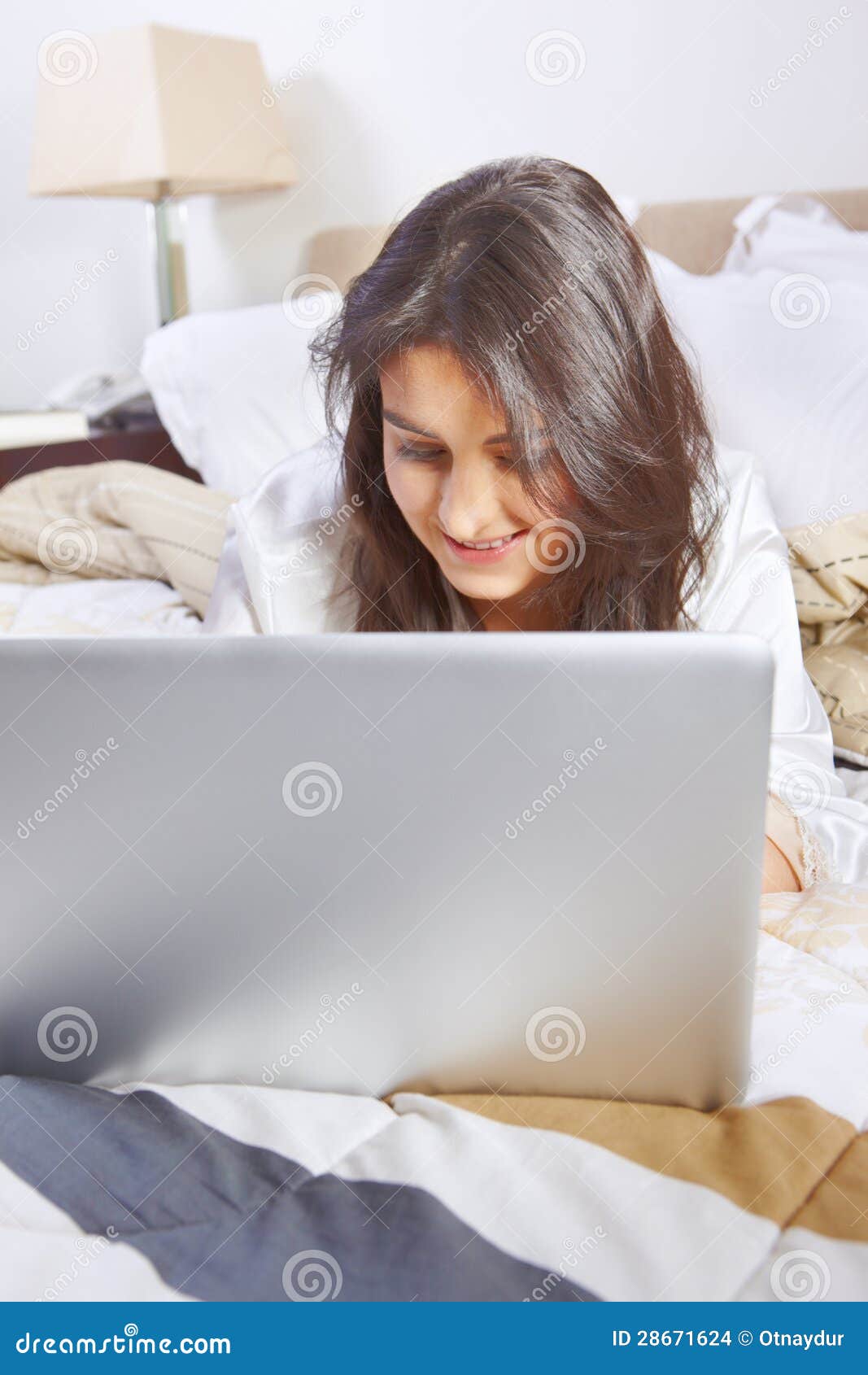 Browsing internet on bed stock photo. Image of people - 28671624