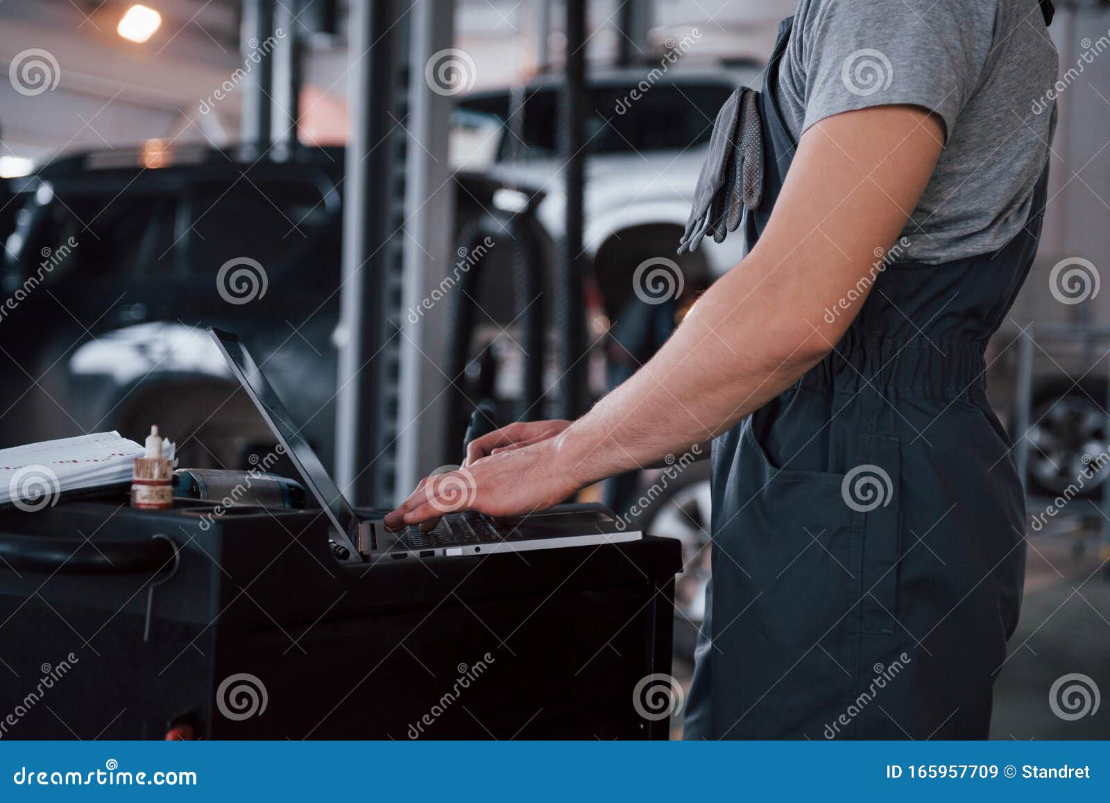Browsing the Internet. Worker Stands Indoors in Uniform Does Reports ...