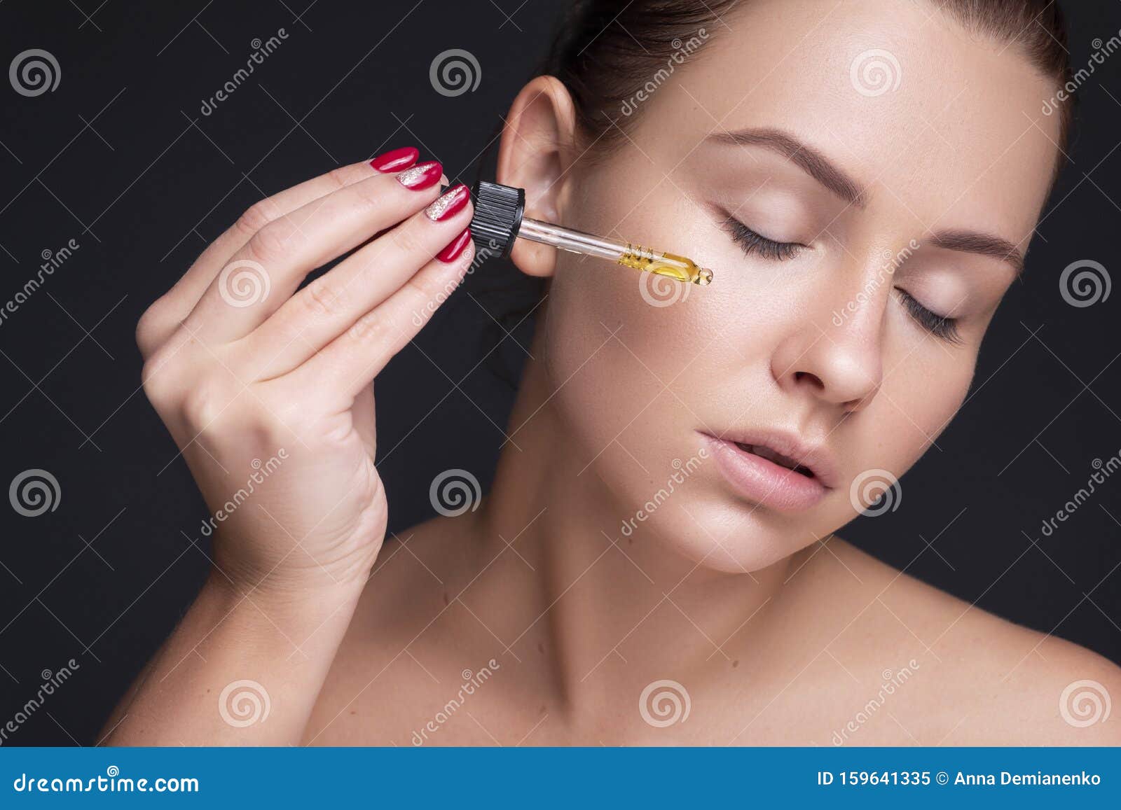 Brunette Caucasian Woman Apply Hyaluronic Acid From A Bottle Using A