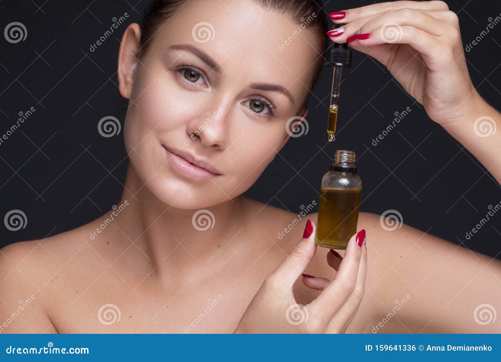 Brunette Caucasian Woman Apply Hyaluronic Acid From A Bottle Using A