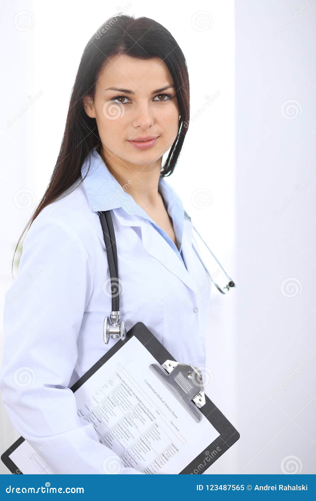 Brunette Female Doctor Standing Straight At Hospital Medicine And