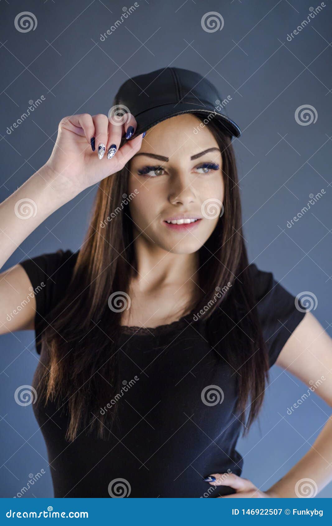 Brunette Girl Holding Her Cap while Posing Studio Stock Image - Image ...