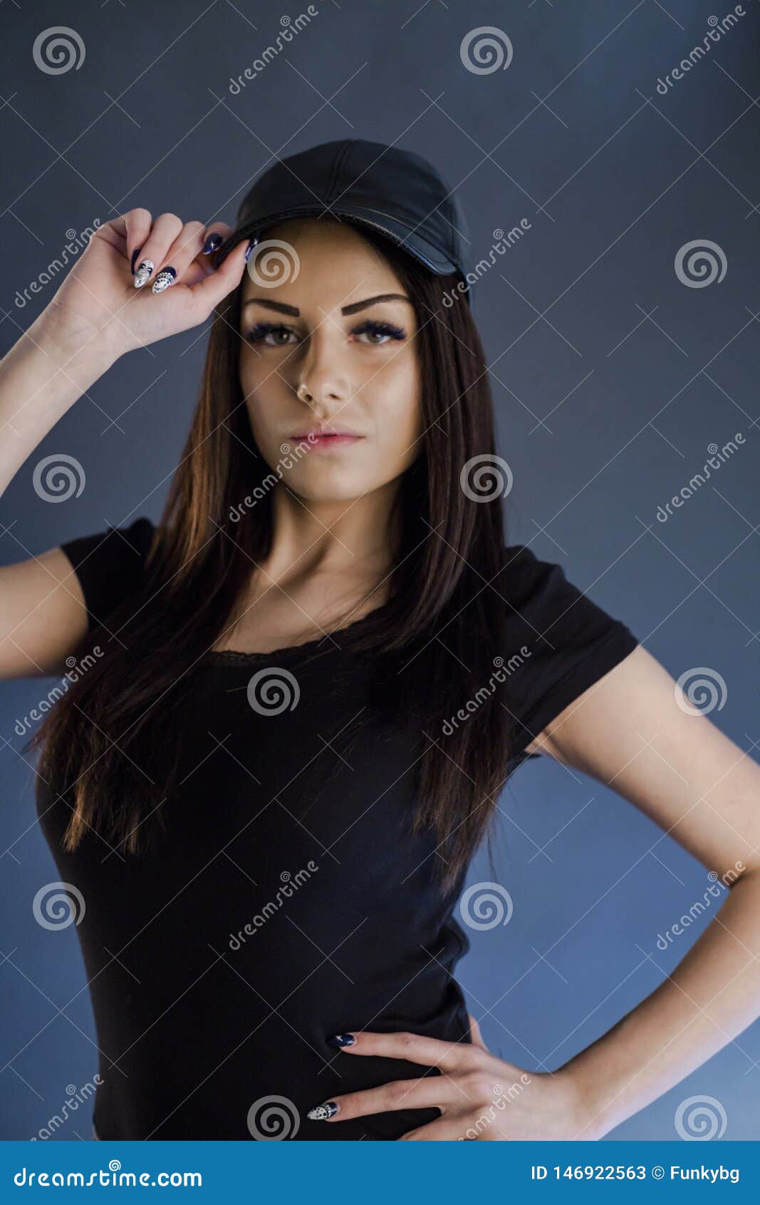 Brunette Girl Holding Her Cap while Posing Studio Stock Image - Image ...