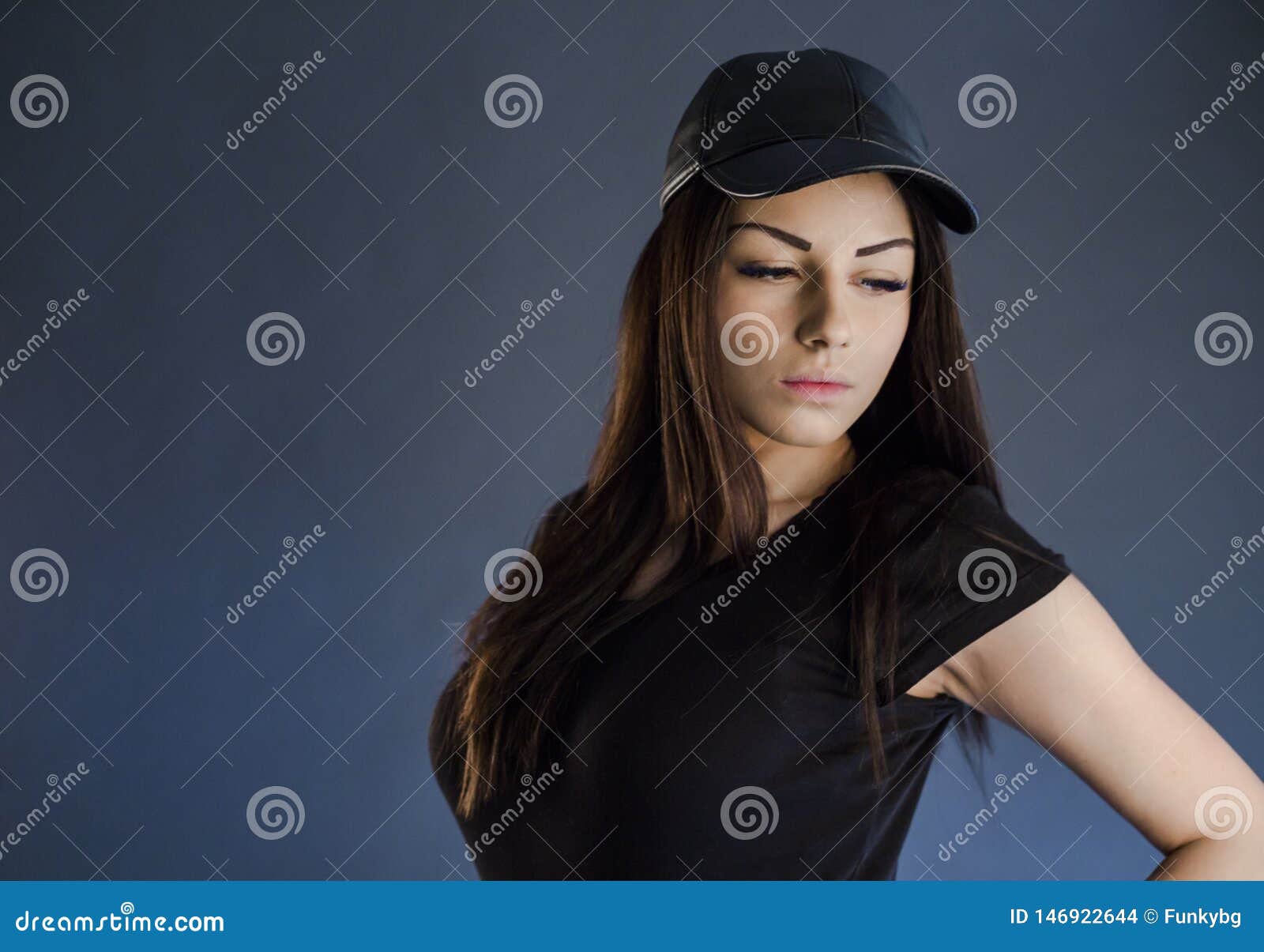Brunette Girl Holding Her Cap while Posing Studio Stock Photo - Image ...