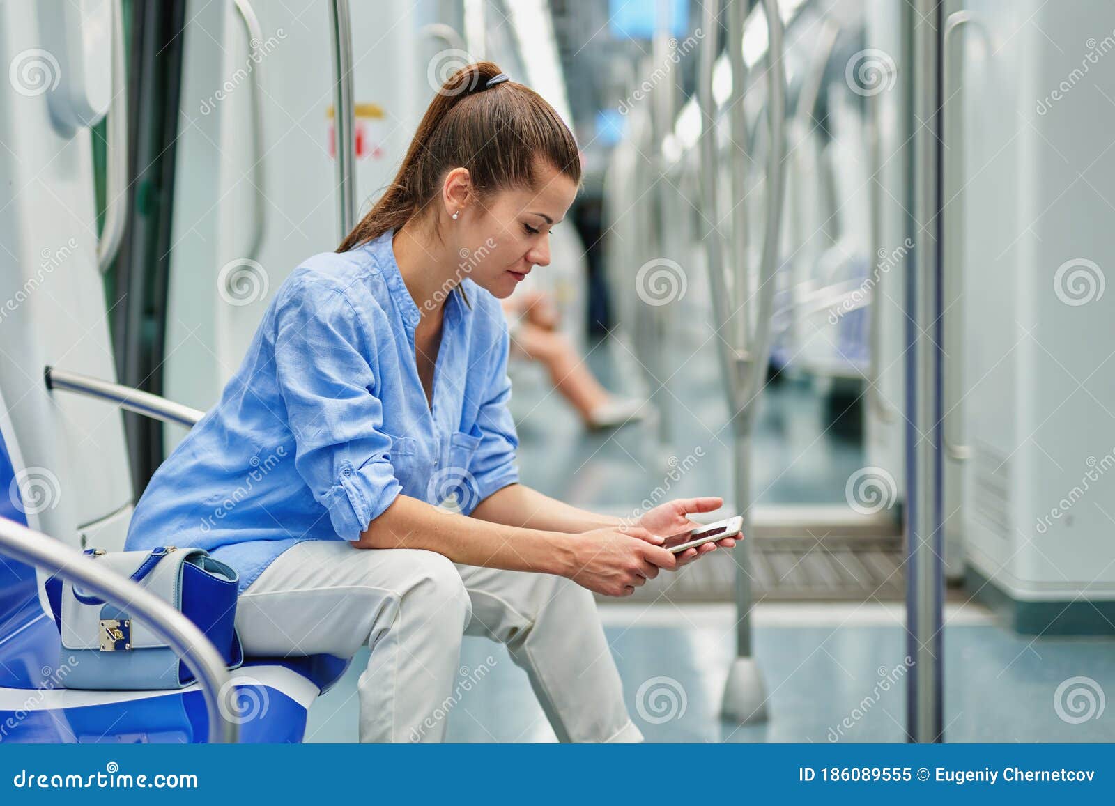 Brunette Girl Using Cell Phone at Subway. Stock Image - Image of city ...