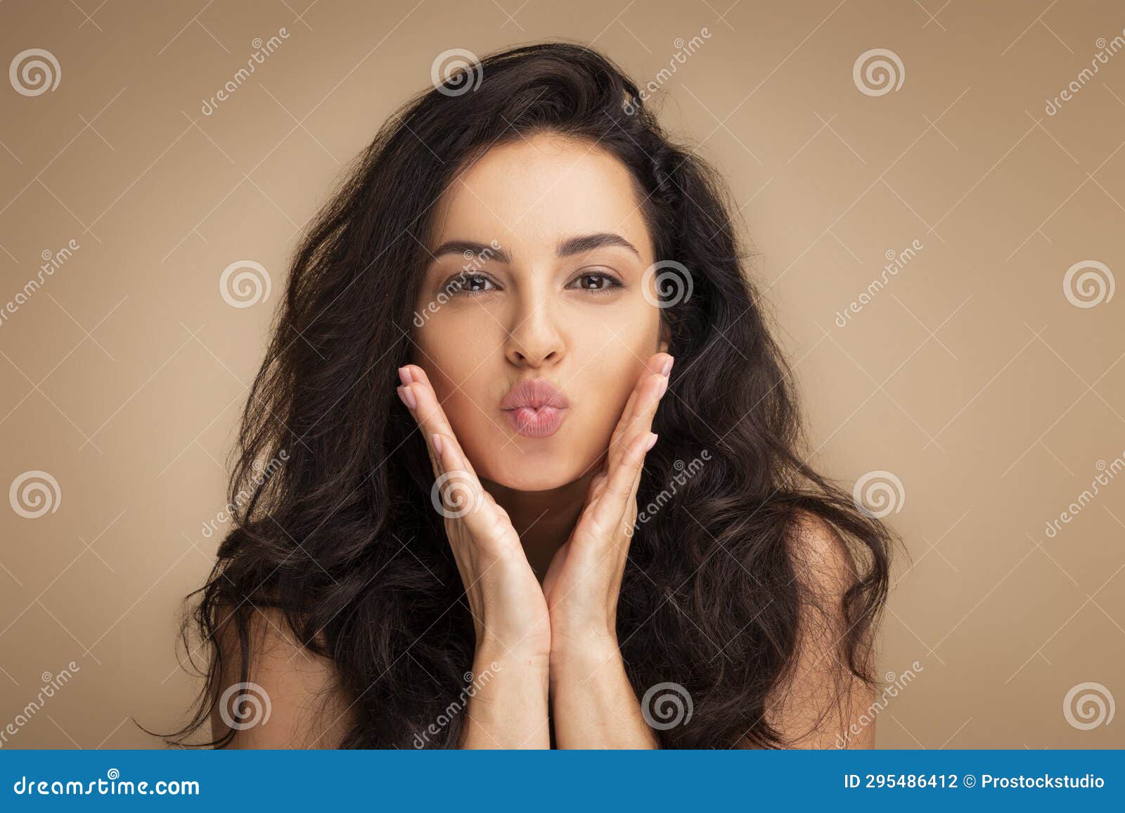 Brunette Millennial Beauty Portrait Against Studio Backdrop Stock Photo ...