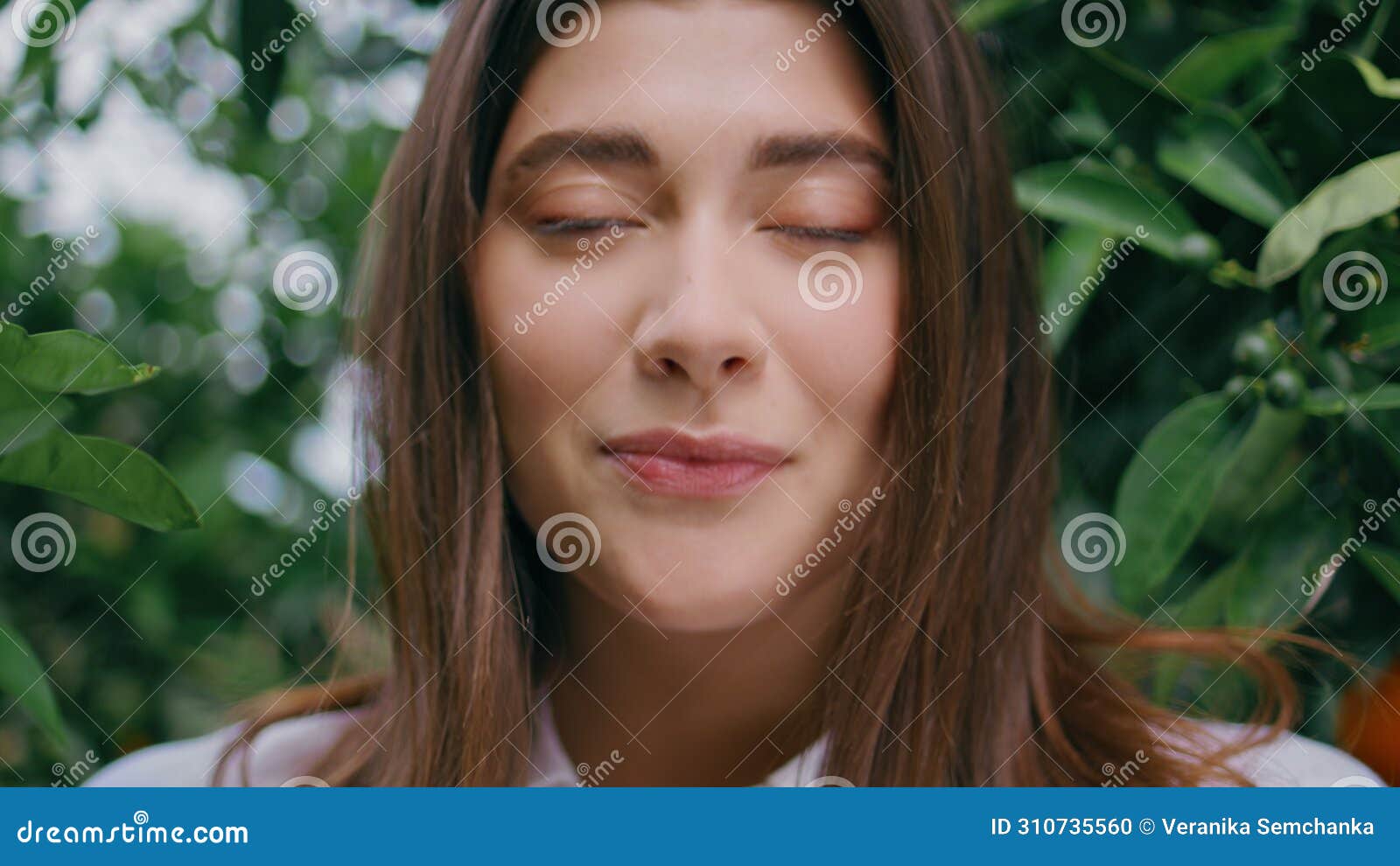 Brunette Model Holding Orange At Green Leaves Portrait Woman Looking