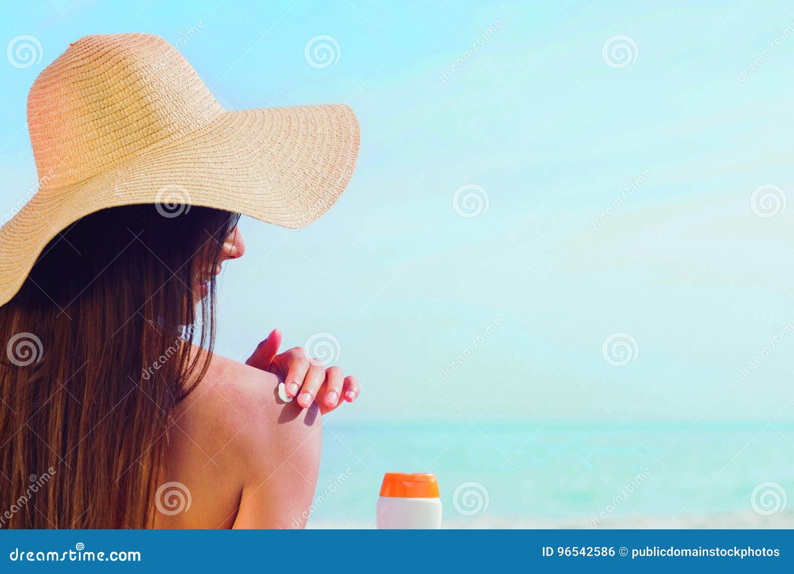 Brunette Putting Sunscreen On Her Shoulder Picture. Image: 96542586