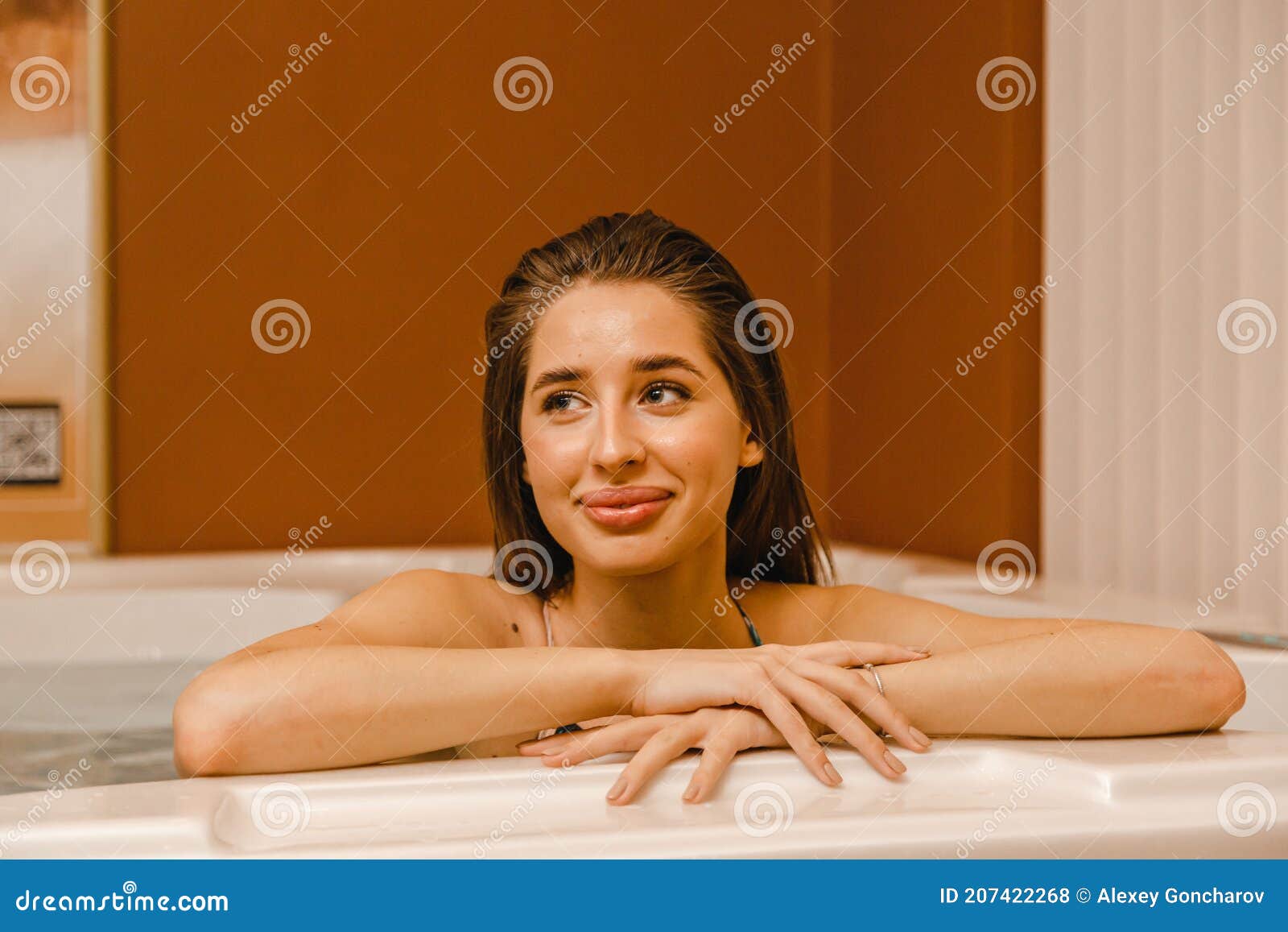 Brunette Relaxes in the Jacuzzi after the Massage, Leaning Her Elbows ...