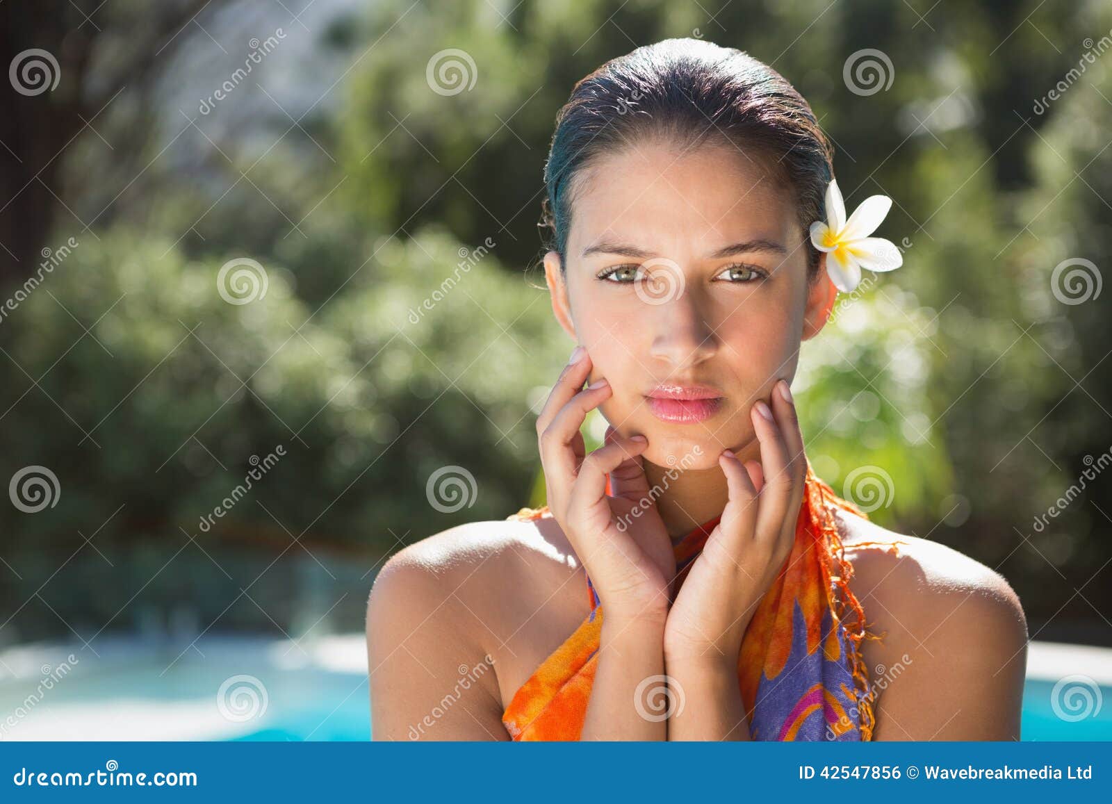 Brunette in Sarong Looking at Camera by the Pool Stock Photo - Image of ...