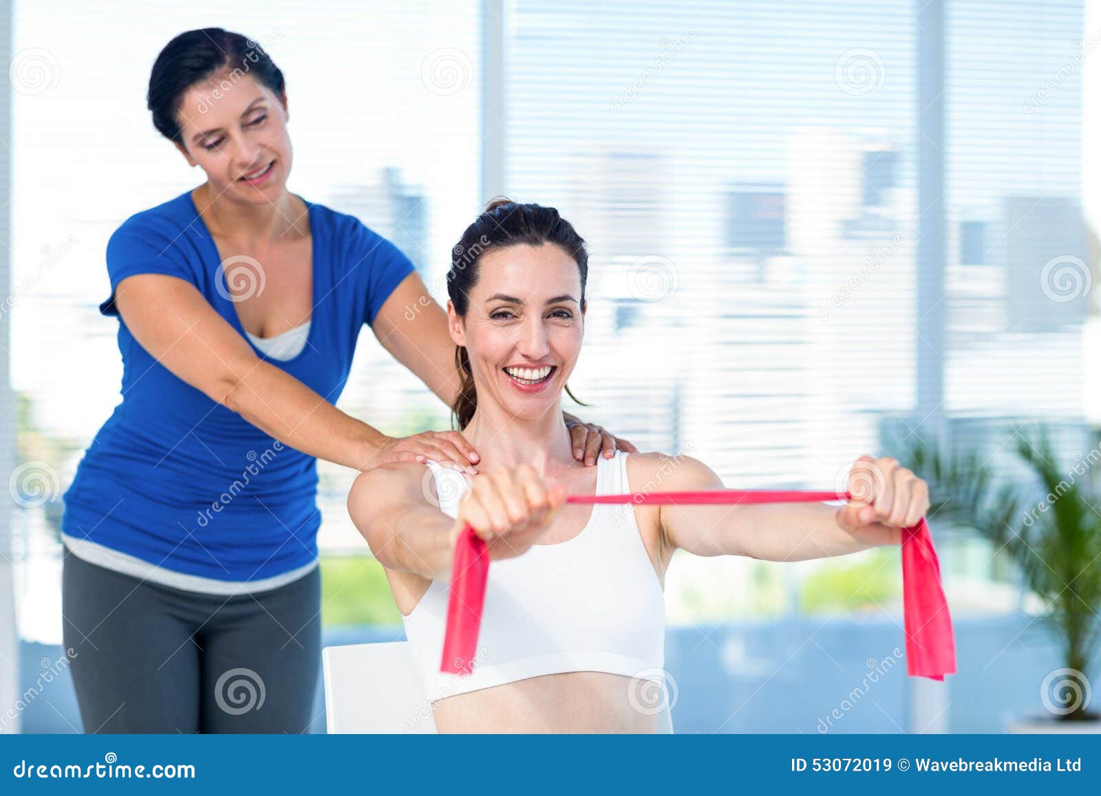 Brunette Stretching with Her Coach and Pink Cloth Stock Image - Image ...