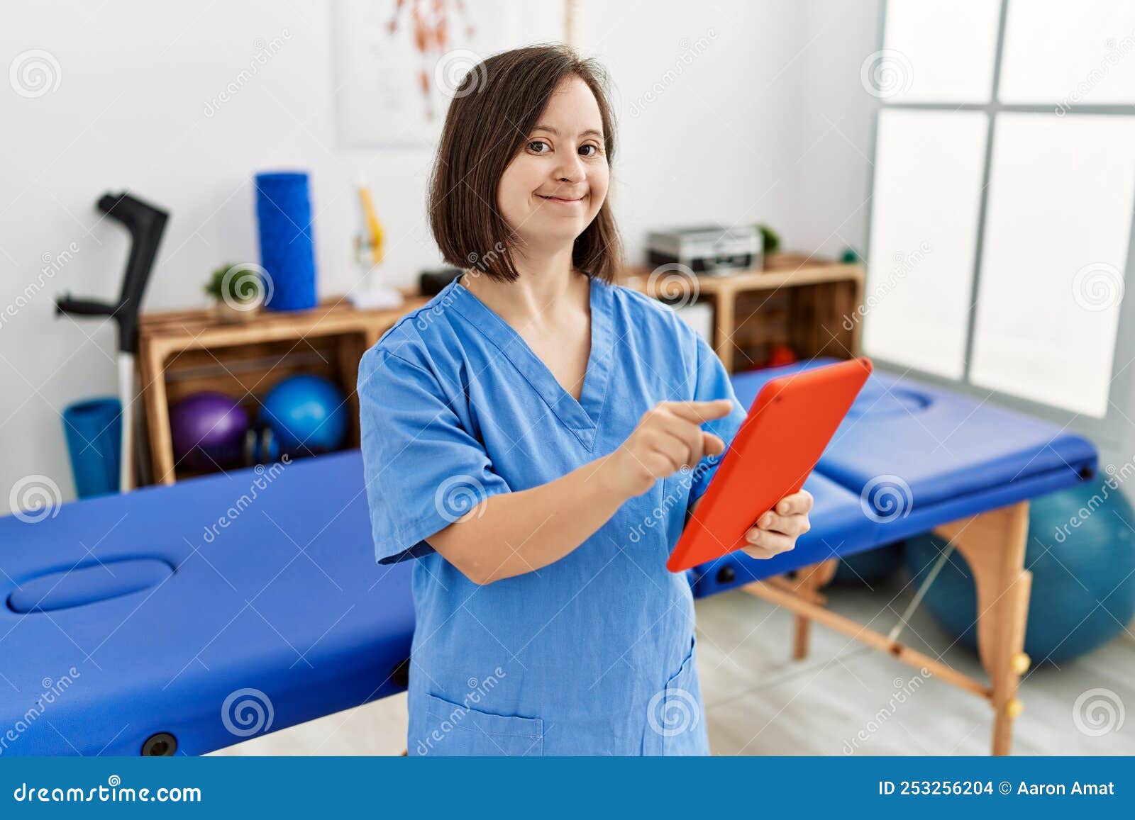 Brunette Woman with Down Syndrome Working Using Tablet at Physiotherapy ...