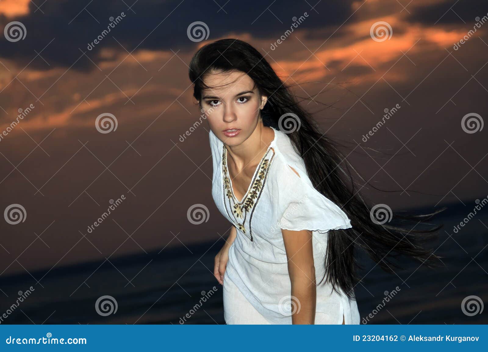 Brunette Woman Over Dusk Sky at Sunset Stock Photo - Image of orange ...