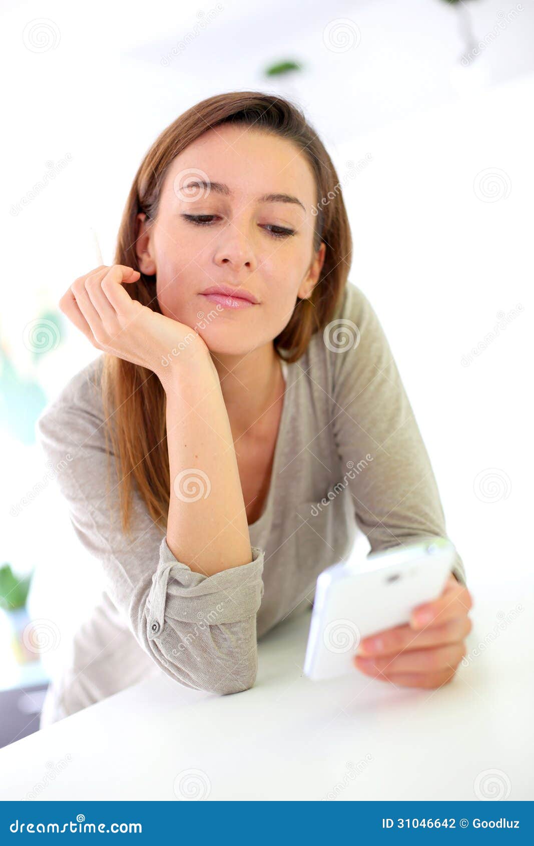 Brunette Woman Reading Message from Smartphone Stock Photo - Image of ...