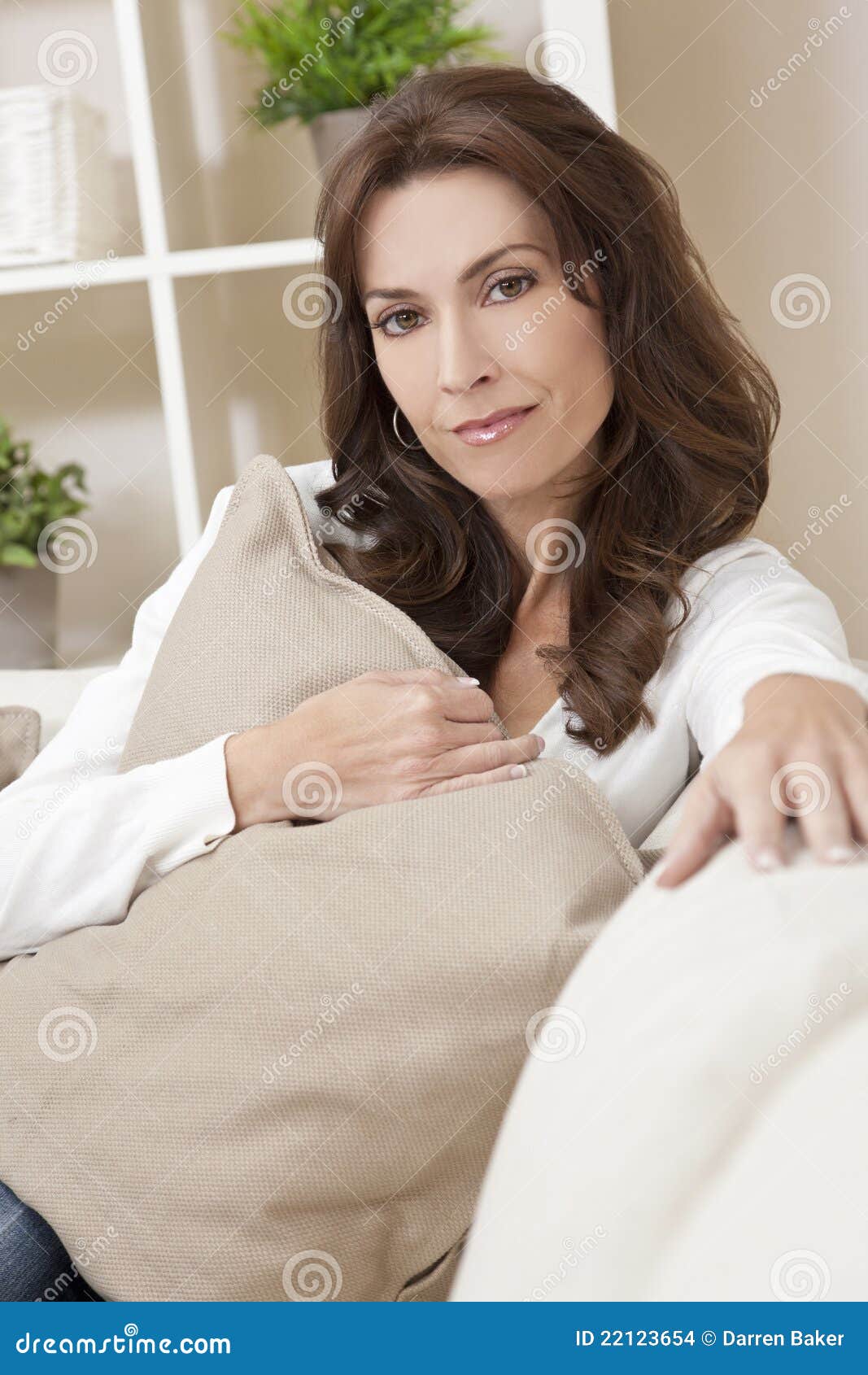 Brunette Woman Sitting Thinking at Home on Sofa Stock Photo - Image of ...
