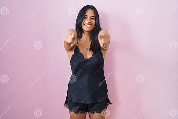 Brunette Woman Wearing Black Pajama Pointing To You And The Camera With