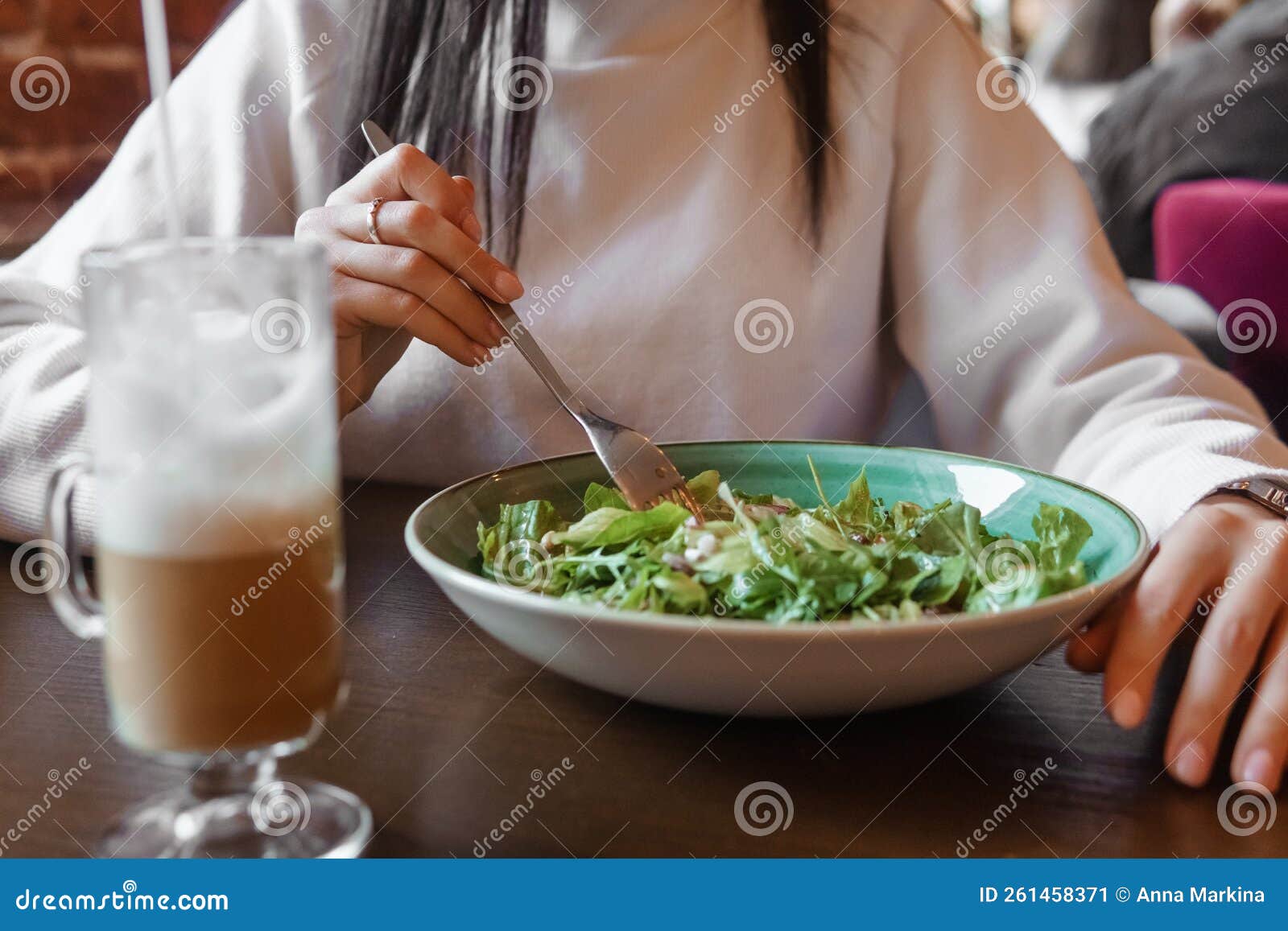 The Brunette is Working with a Tablet at a Table in a Cafe. Drinks ...