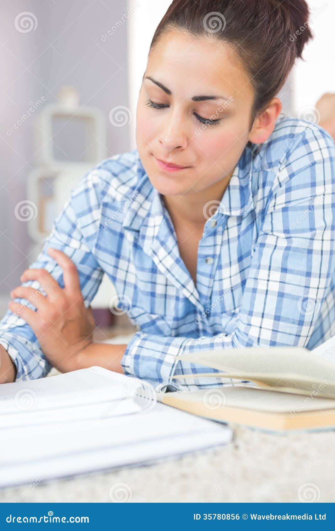 Brunette Young Student Doing Assignments Lying on a Carpet Stock Photo ...