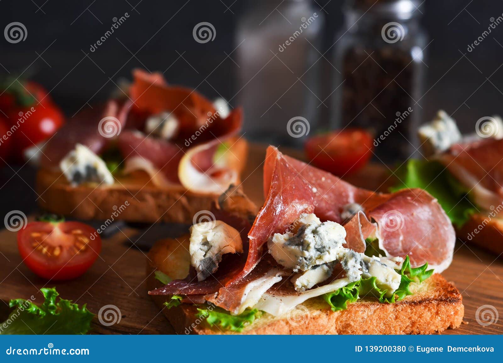 Bruschetta with Prosciutto, Salad Frieze and Cheese on the Kitchen ...