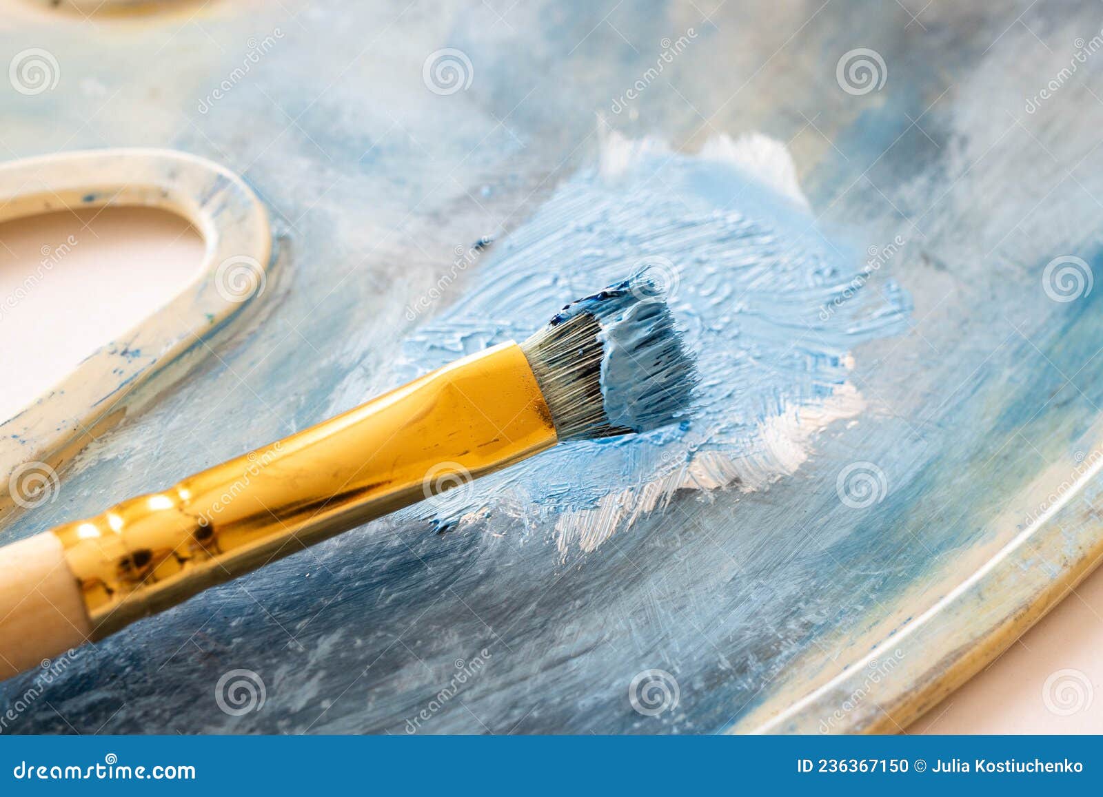 A Brush with Blue Oil Paint Rests on the Palette. Stock Photo - Image ...
