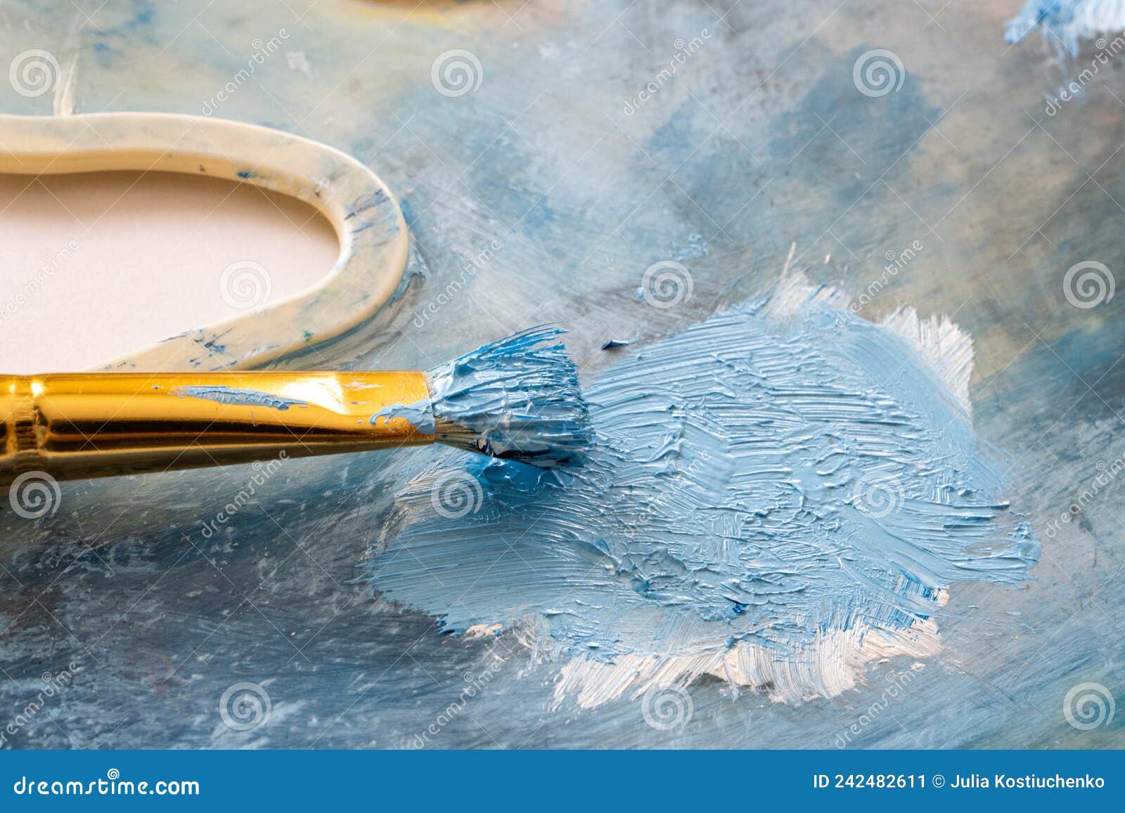 A Brush with Blue Oil Paint Rests on the Palette. Stock Image - Image ...