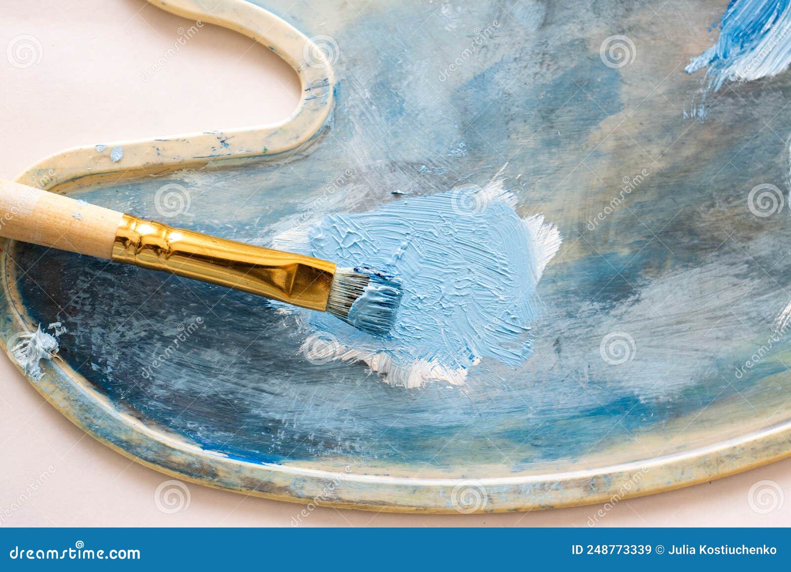 A Brush with Blue Oil Paint Rests on the Palette. Stock Image - Image ...