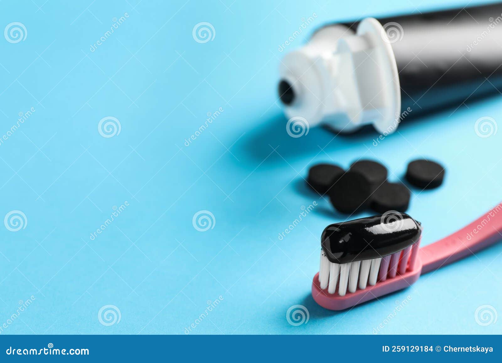 Brush with Charcoal Toothpaste on Light Blue Background. Space for Text ...