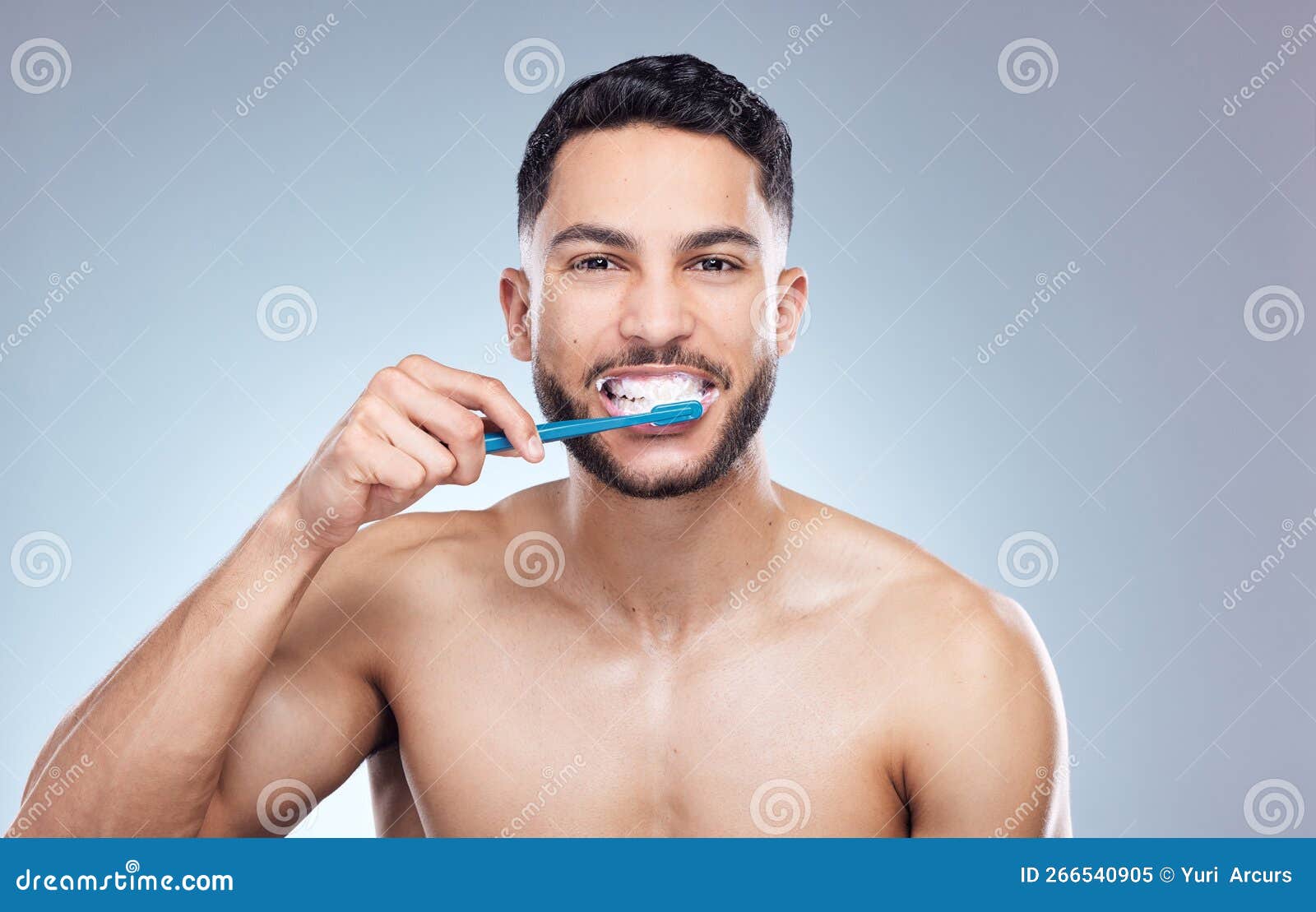 Brush in Slow Circles. a Young Man Brushing His Teeth Against a Studio ...