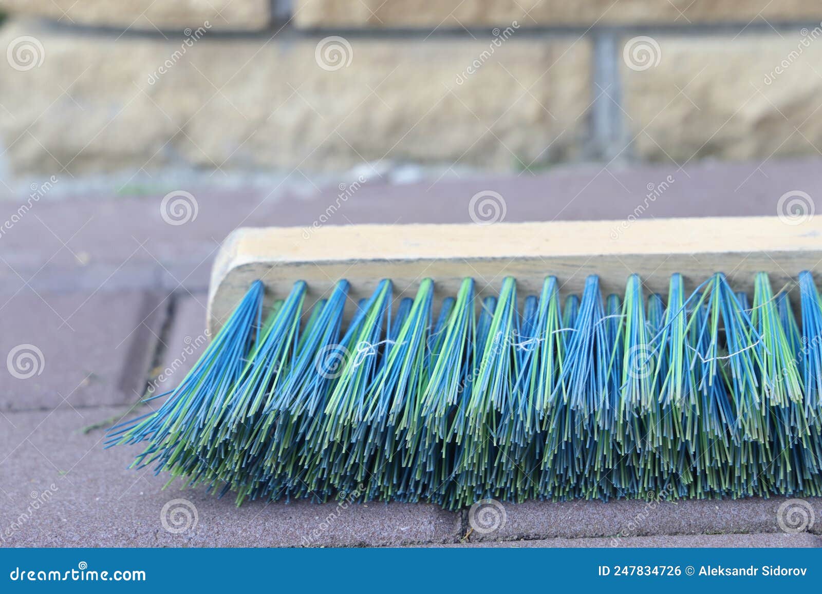 Brush for Sweeping Footpaths Lies on a Stone Pavement, Multi Colored ...