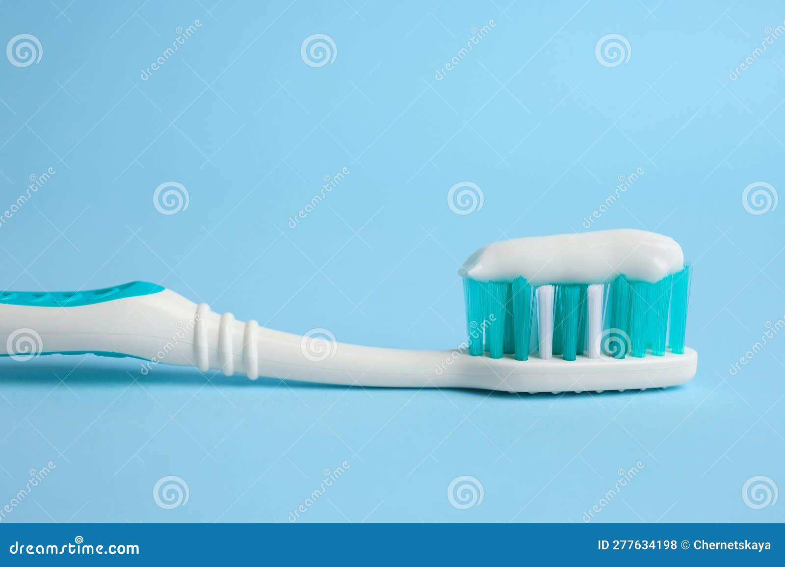 Brush with Toothpaste on Light Blue Background, Closeup Stock Photo ...