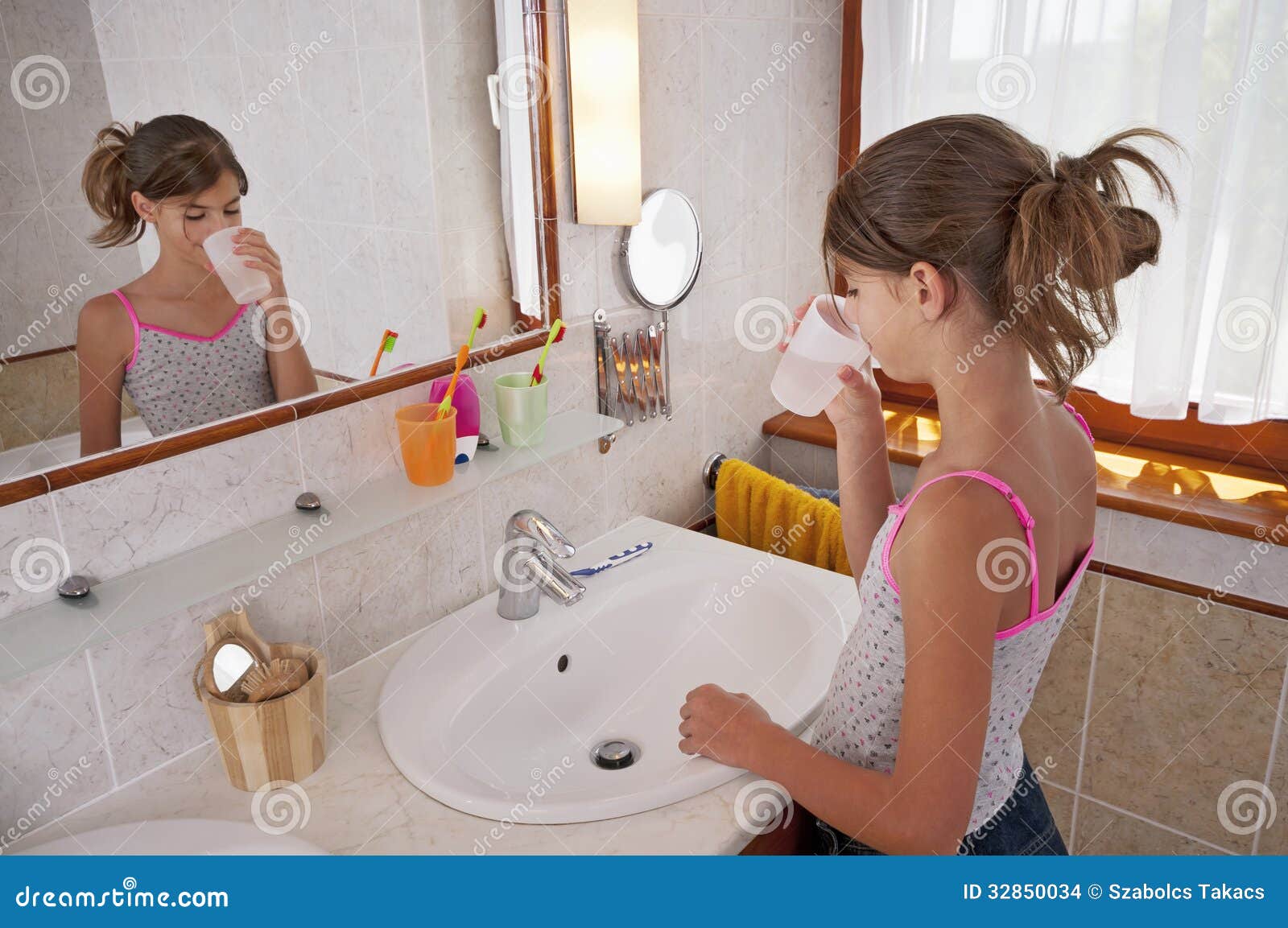 Brushing teeth in bathroom stock photo. Image of activity - 32850034