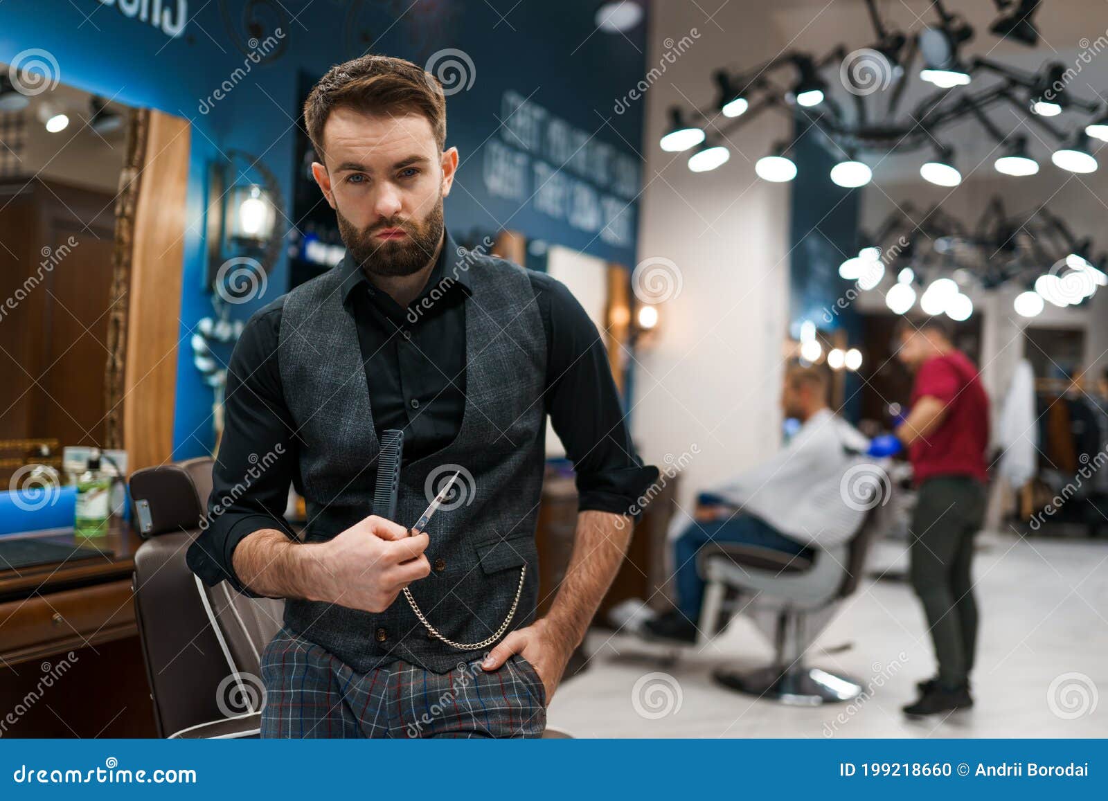 Brutal Barber Master with Scissors and a Comb in His Hands. Stock Photo ...