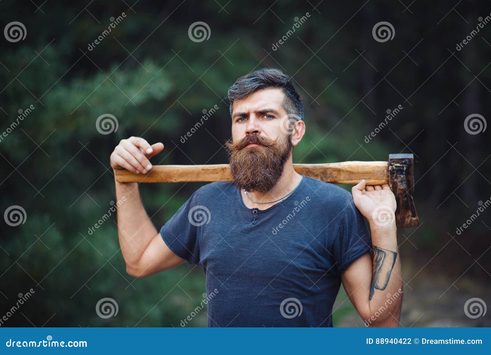 Brutal Bearded Man with a Smart Mustache with an Ax in His Hands in the ...