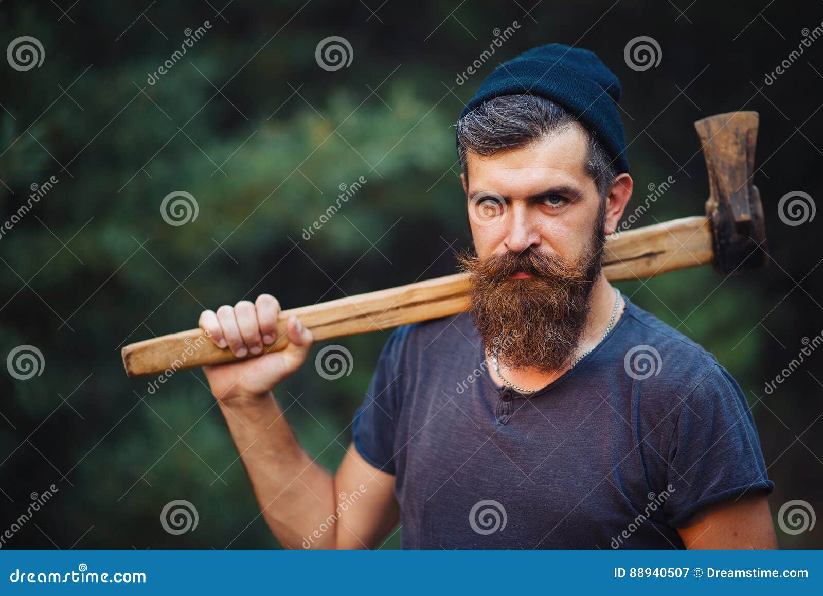 Brutal Bearded Man with a Smart Mustache with an Ax in His Hands in the ...