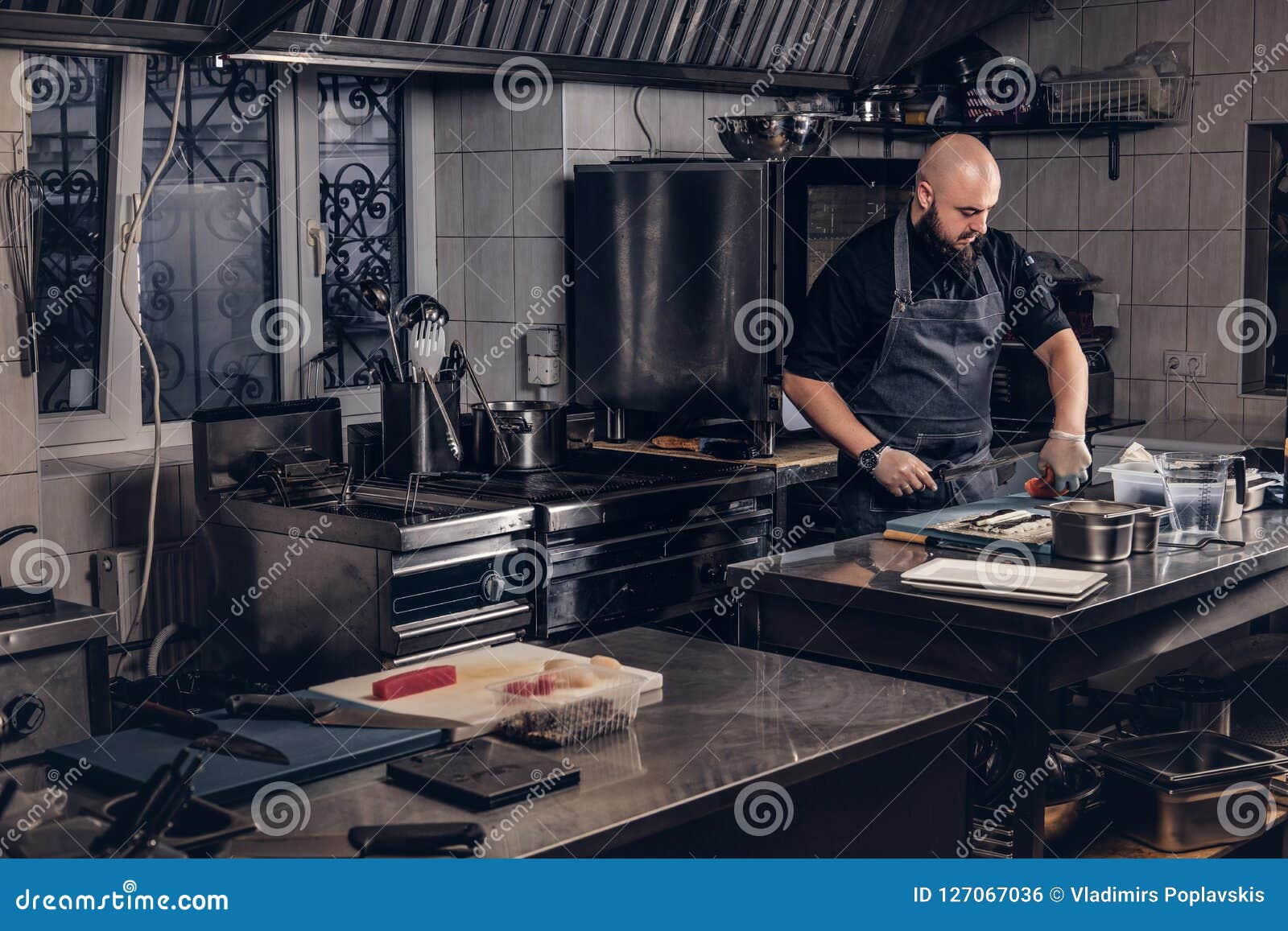 Brutal Chef Dressed in Uniforms Preparing Sushi in the Kitchen. Stock ...