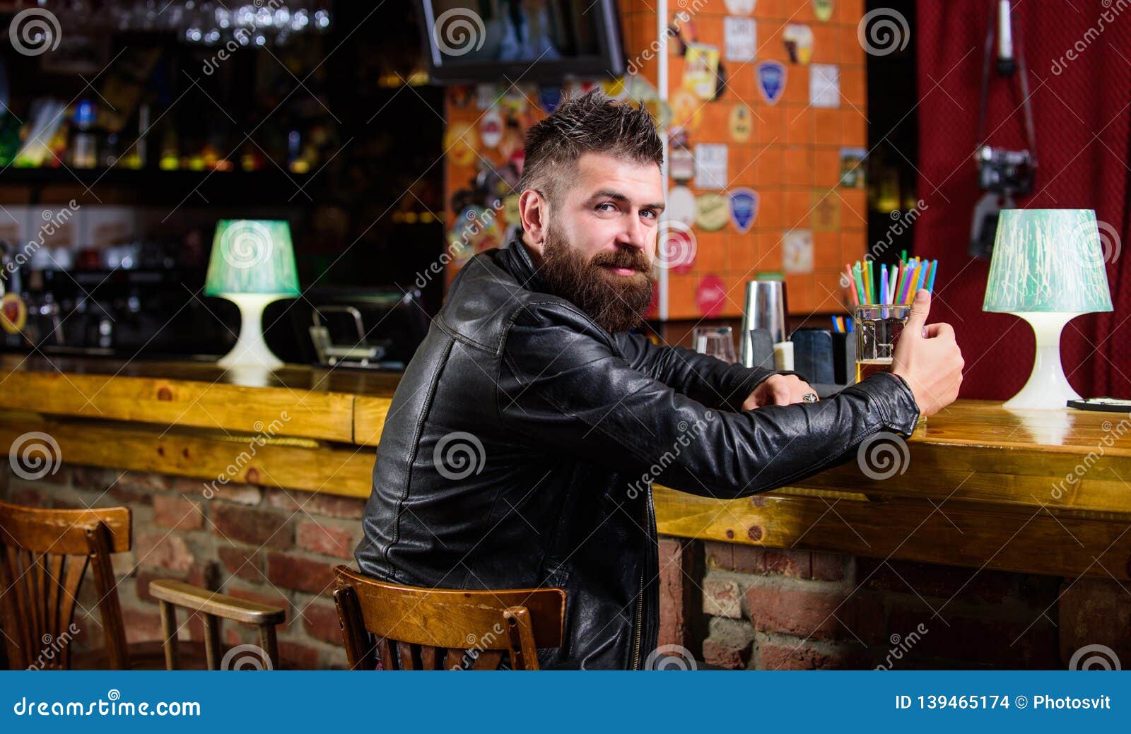 Brutal Hipster Bearded Man Sit at Bar Counter Drink Beer. Friday ... Brutal Hipster Bearded Man Sit at Bar Counter Drink Beer. Friday ...