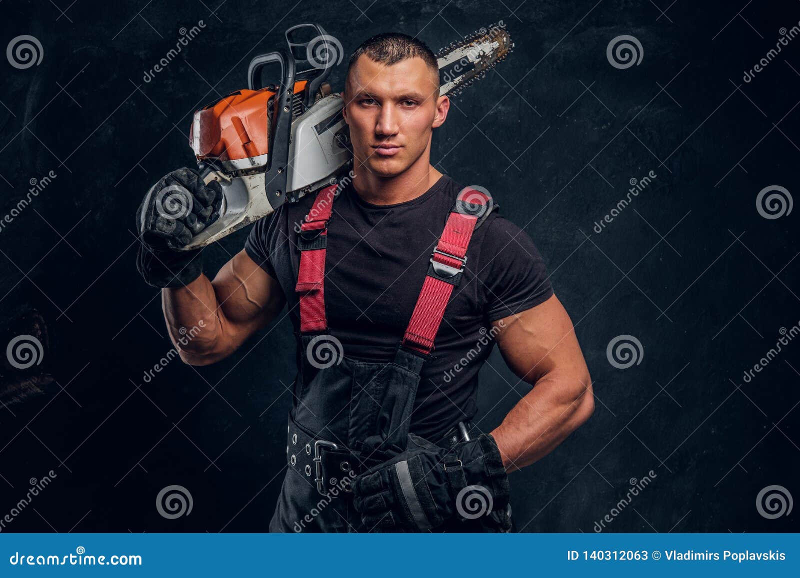 Brutal Logger Posing with a Chainsaw on His Shoulder and Looking at a ...