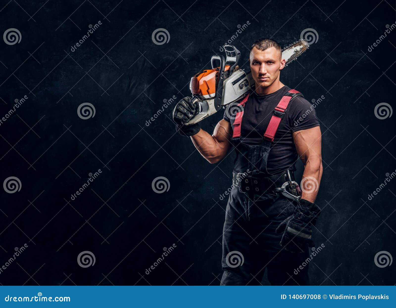 Brutal Logger Posing with a Chainsaw on His Shoulder and Looking at a ...
