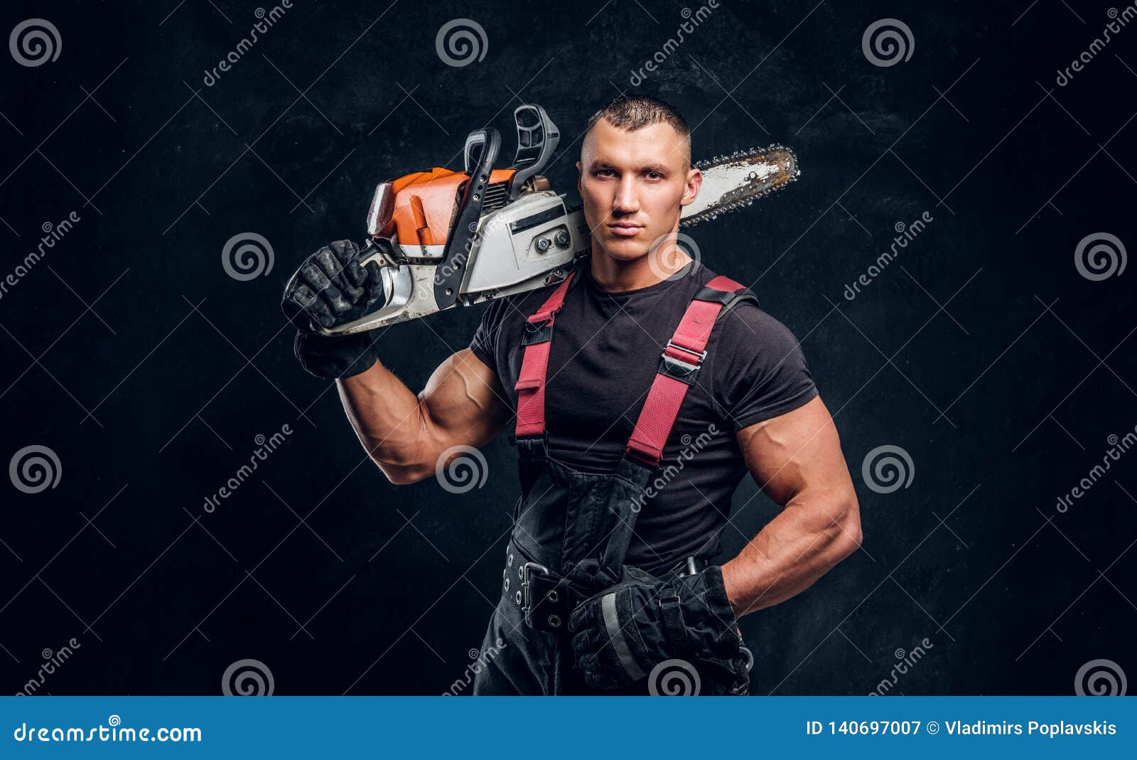 Brutal Logger Posing with a Chainsaw on His Shoulder and Looking at a ...