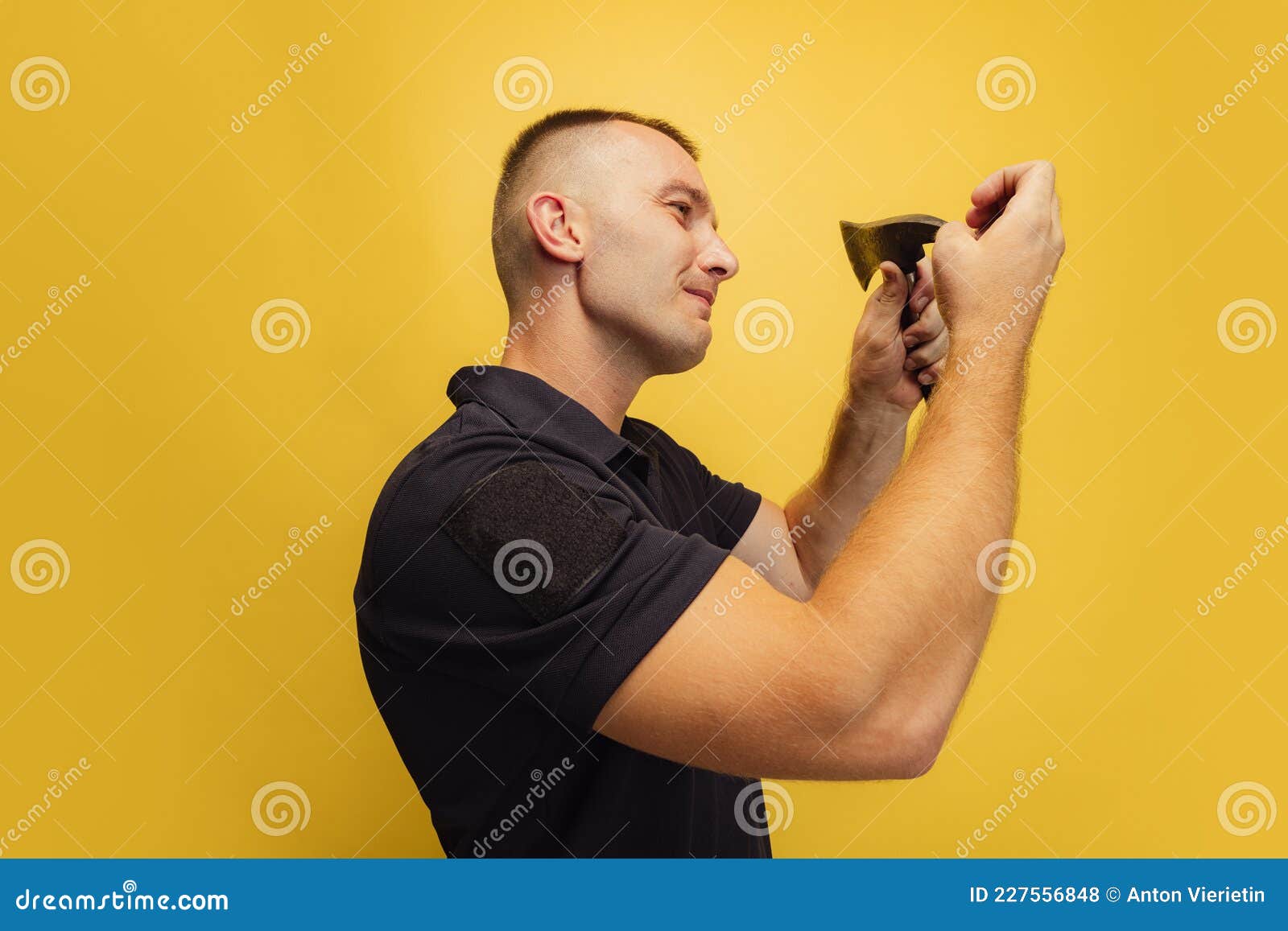 One Young Brutal Man, Firefighter Cutting Nails with an Axe Over Yellow ...