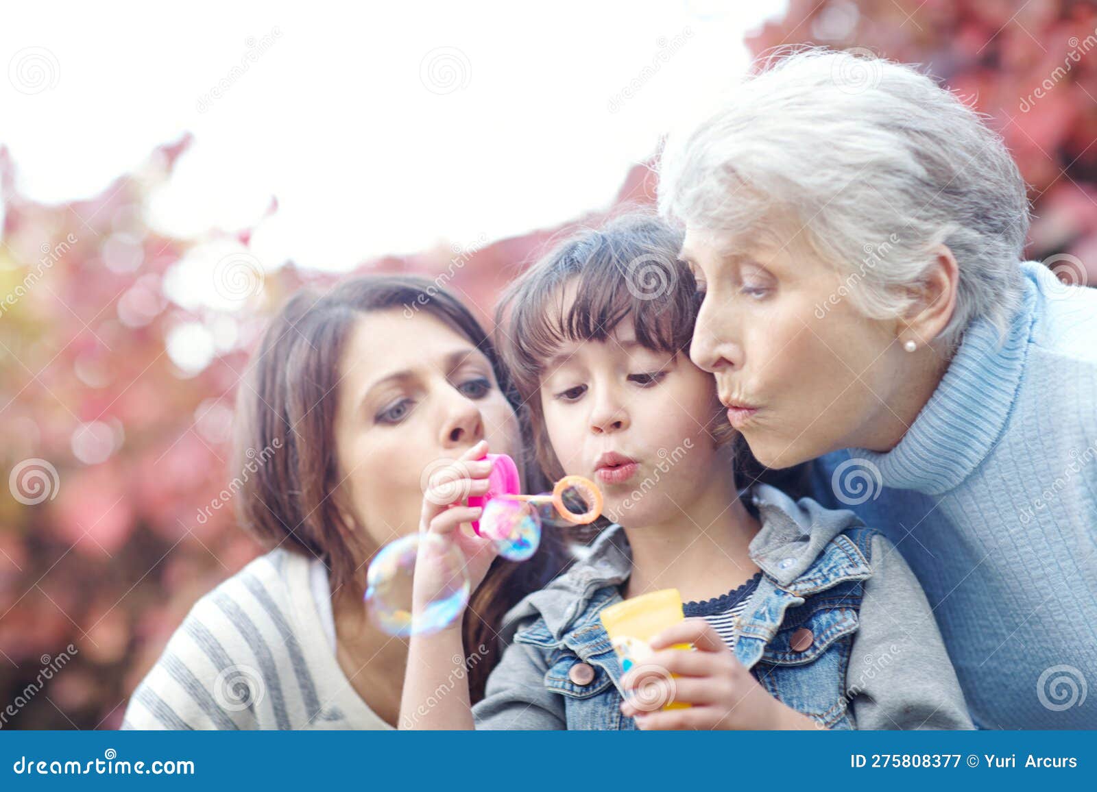 Bubble Fun. a Three Generational Family Blowing Bubbles Together. Stock ...