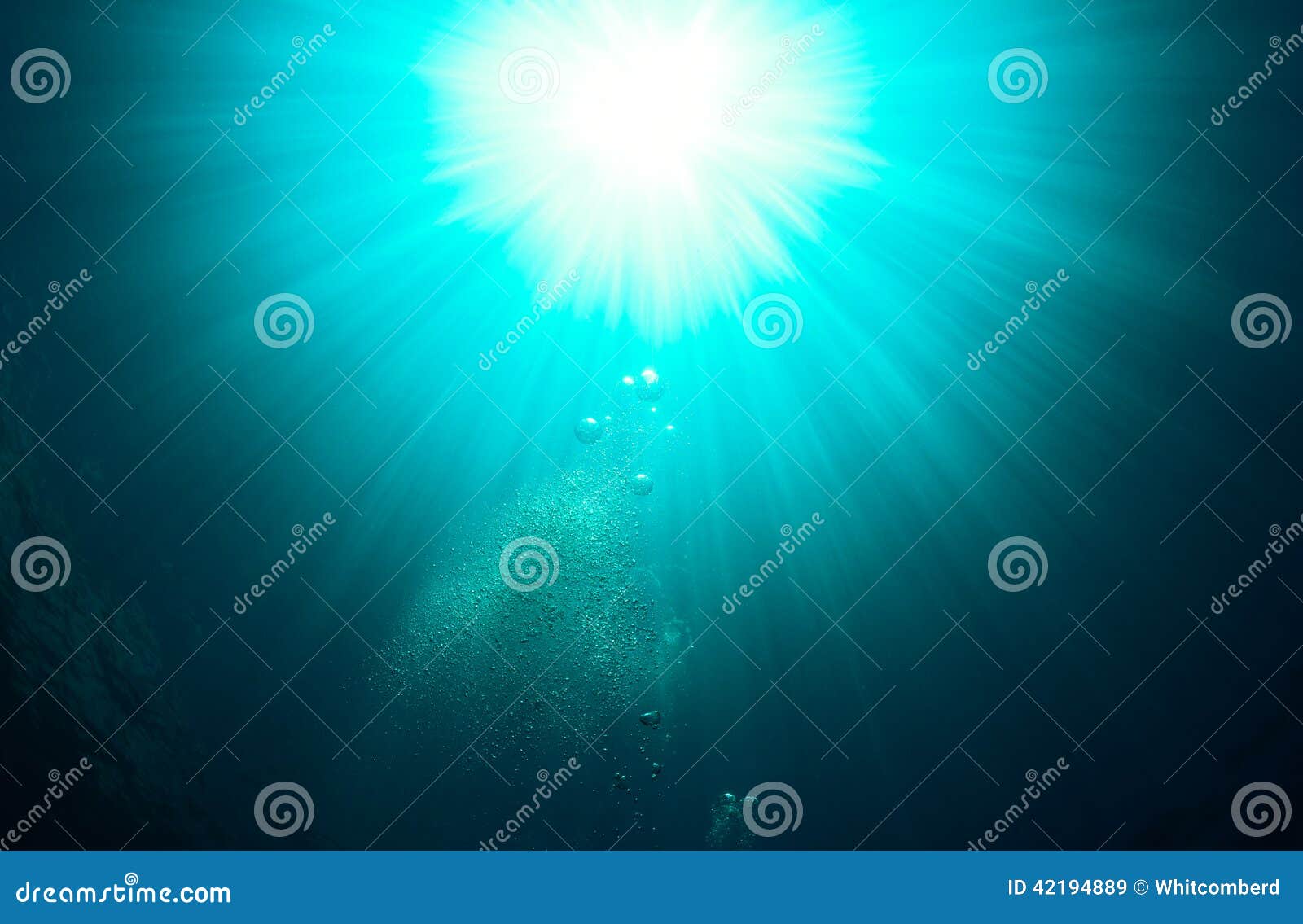 Bubbles and Sunburst on the Ocean Surface Stock Image - Image of blue ...